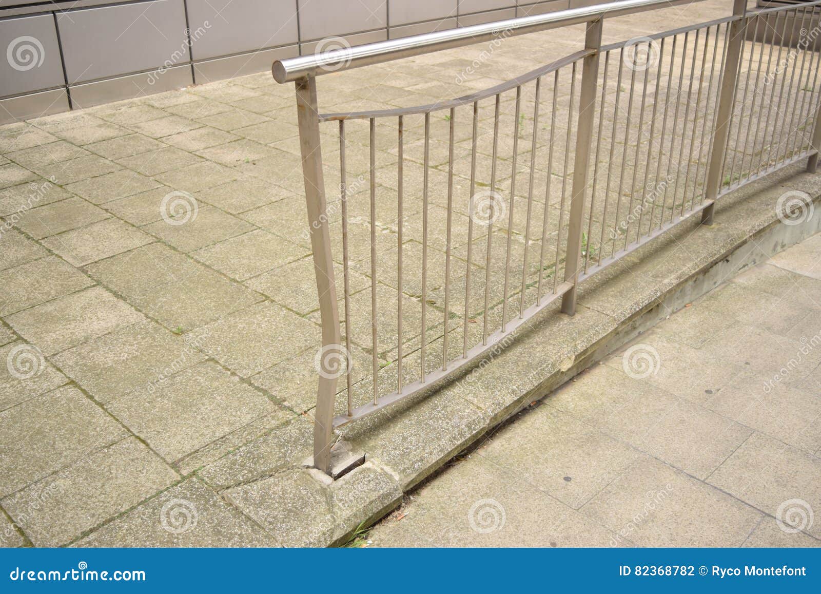 Dented Metallic Railing on the Pavement Stock Photo - Image of dented ...