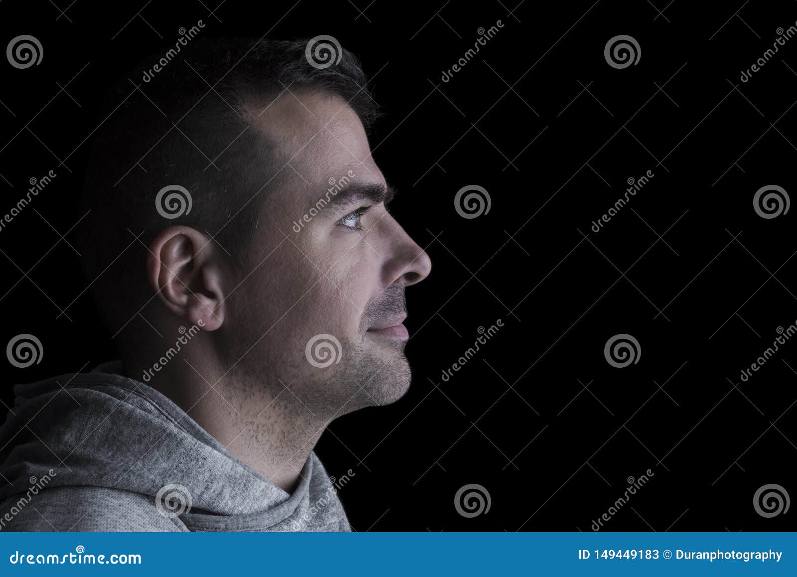 Studio Portrait of a Man Looking Sideways. Black Background. Horizontal ...