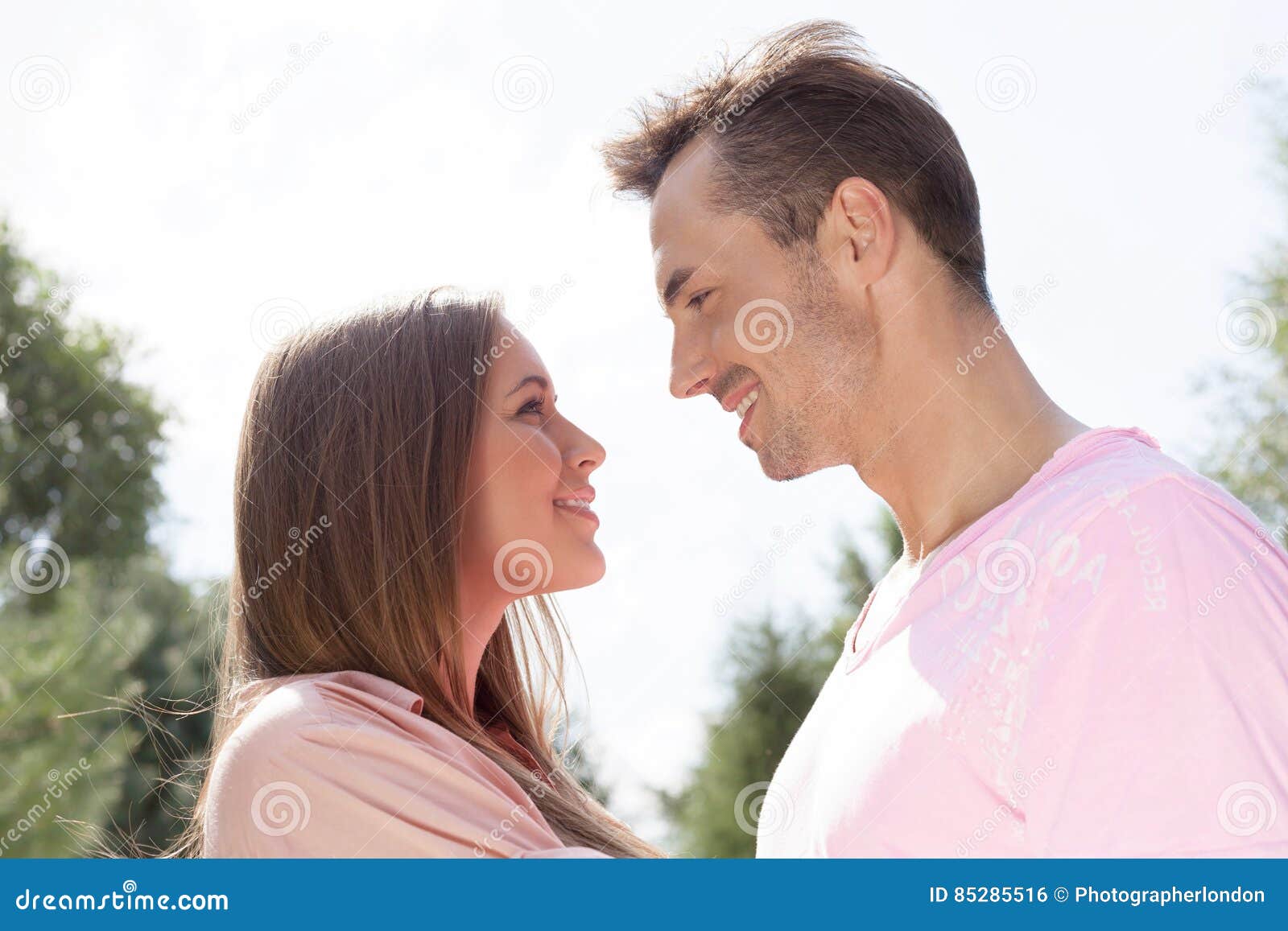 Side View of Affectionate Young Couple Looking at Each Other in Park ...
