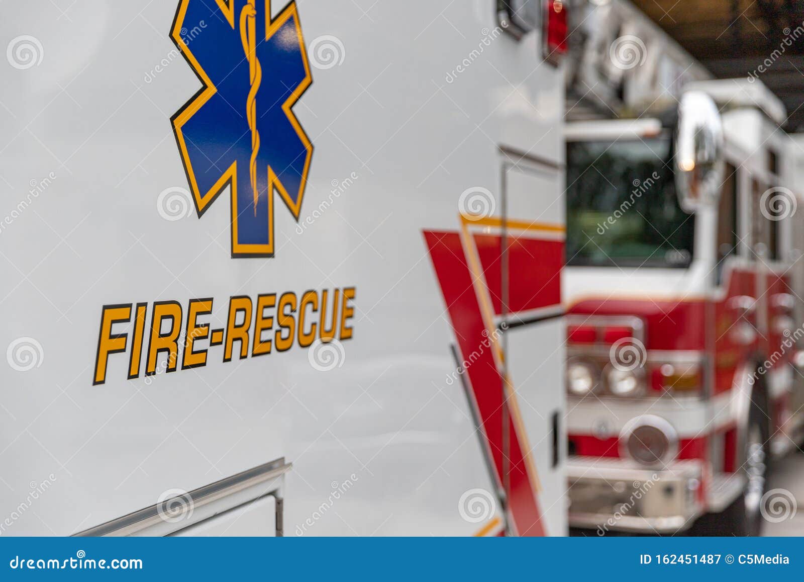 Side View of an Ambulance Rescue Vehicle Parking in Front of a Fire ...