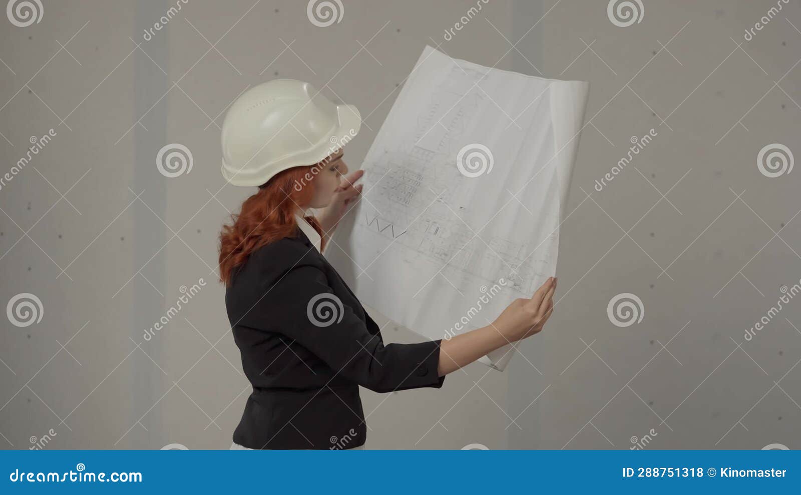 Side View of an Architect Woman Holding a Plan in Her Hands. a Woman is ...