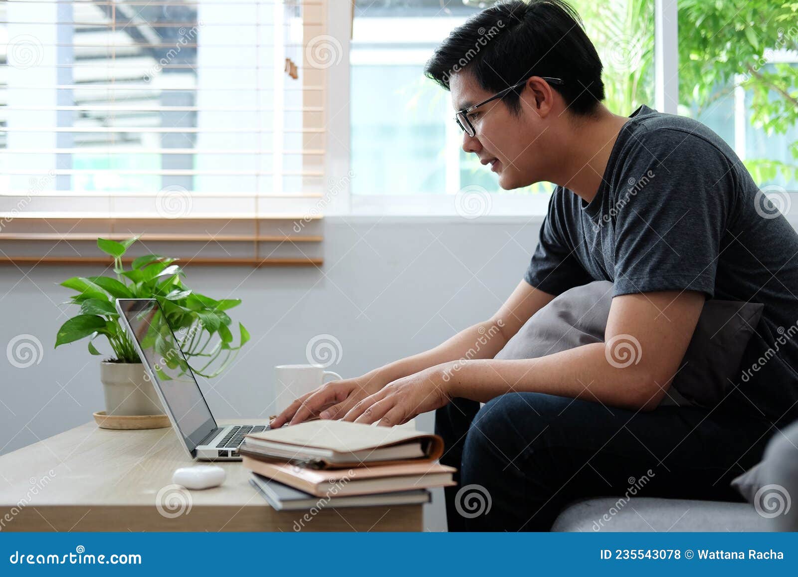 Side View Asian Man Sitting on Sofa and Using Laptop Computer Stock ...