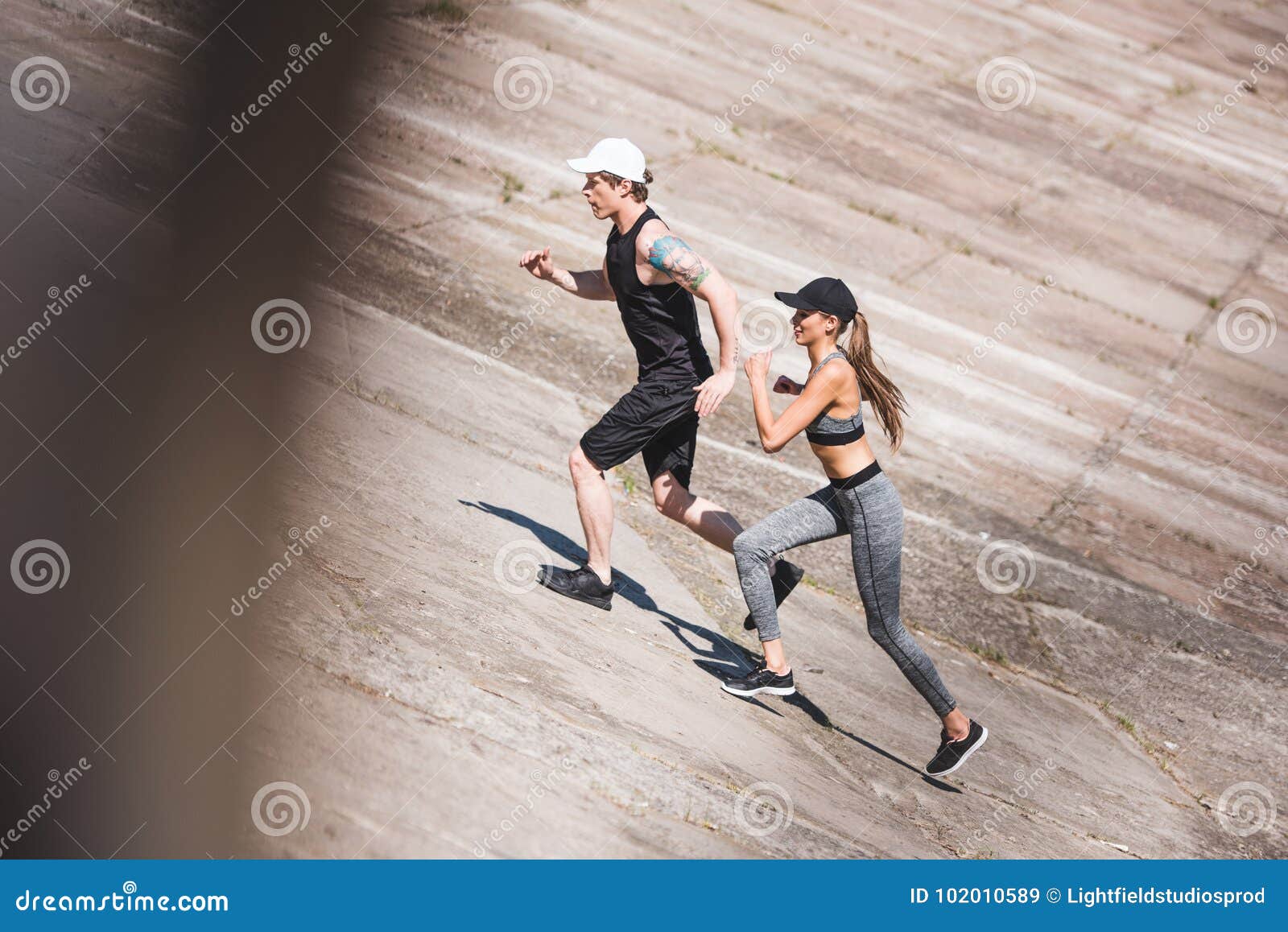 Couple jogging on slabs stock image. Image of workout - 102010589