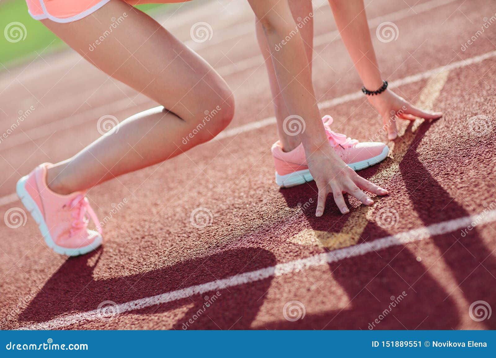 Side View Athletic Woman In Pink Shorts And Tank Tops On Running Track
