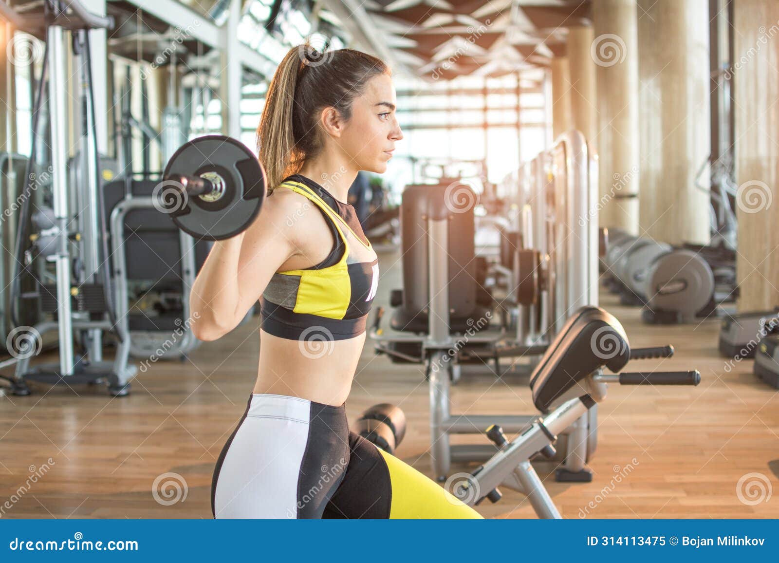 Side View of Attractive Fit Woman Lifting Weights in Gym. Stock Image ...