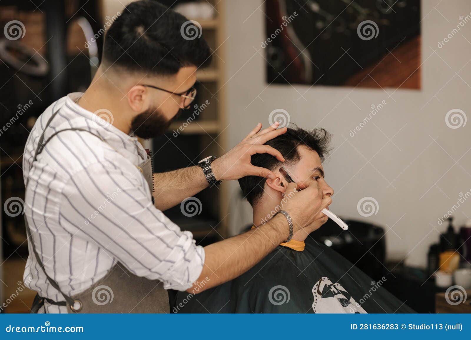 Side View of Barber Using Sharp Blade for Shaving. Handsome Customer ...
