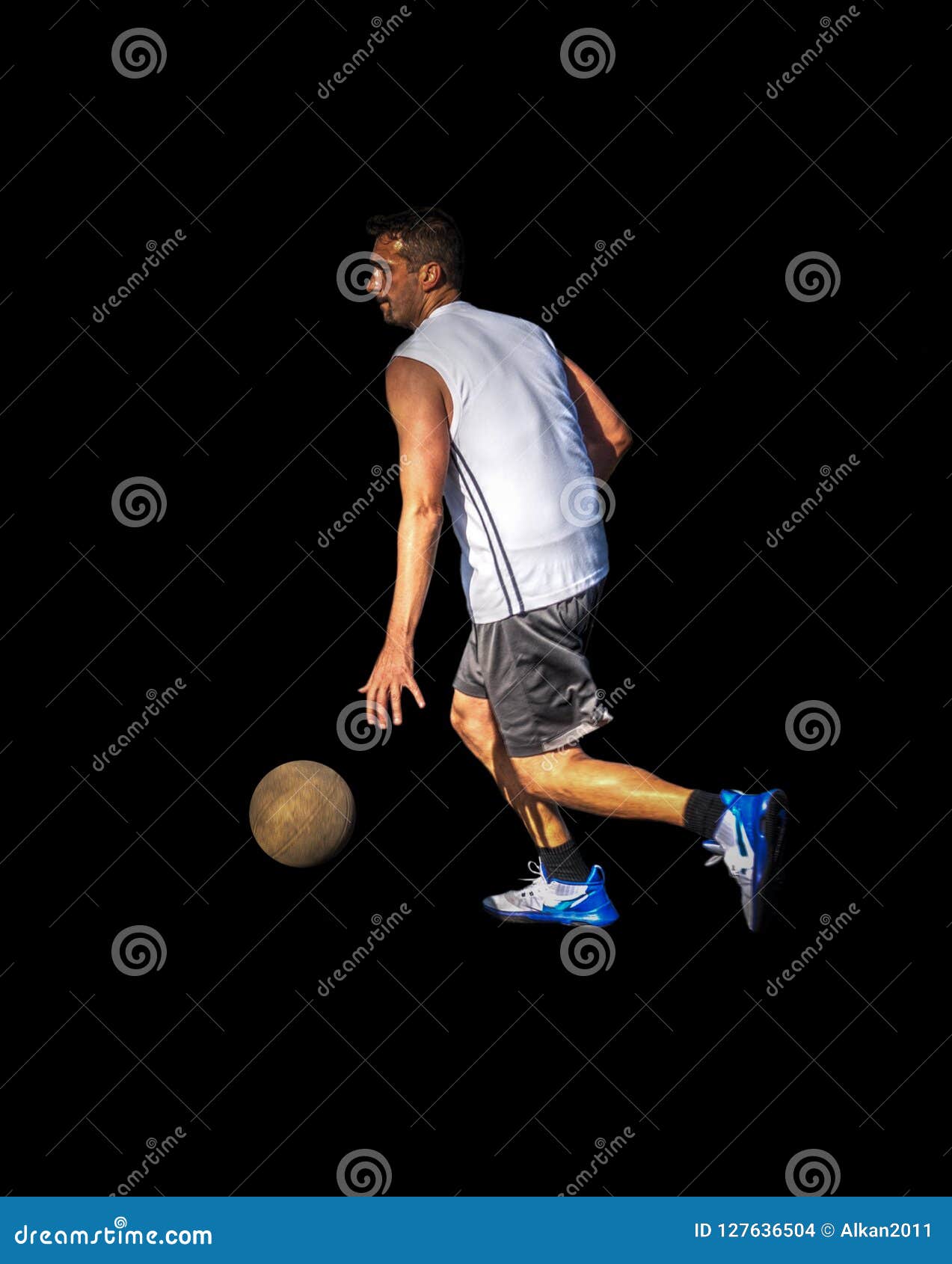 Side View of a Basketball Player Dribbling on Black Stock Photo - Image ...