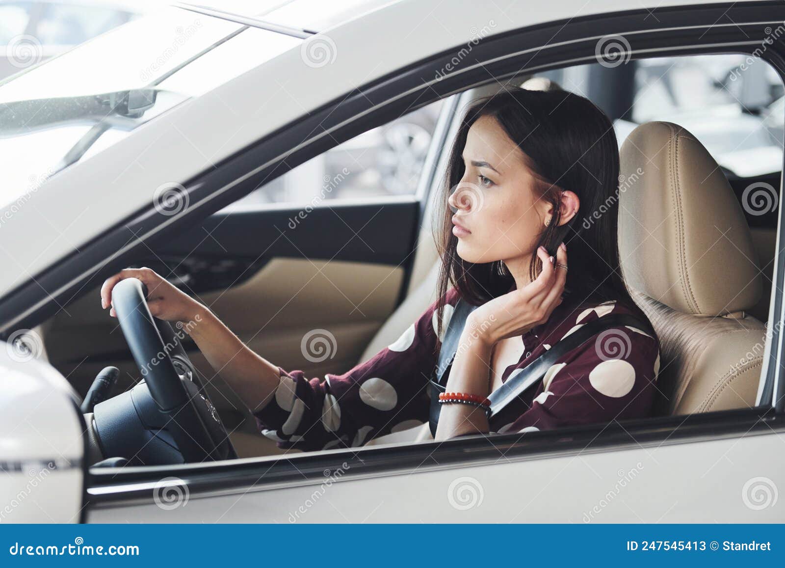 Side View of Beautiful Young Brunette that Inside of Modern Automobile ...