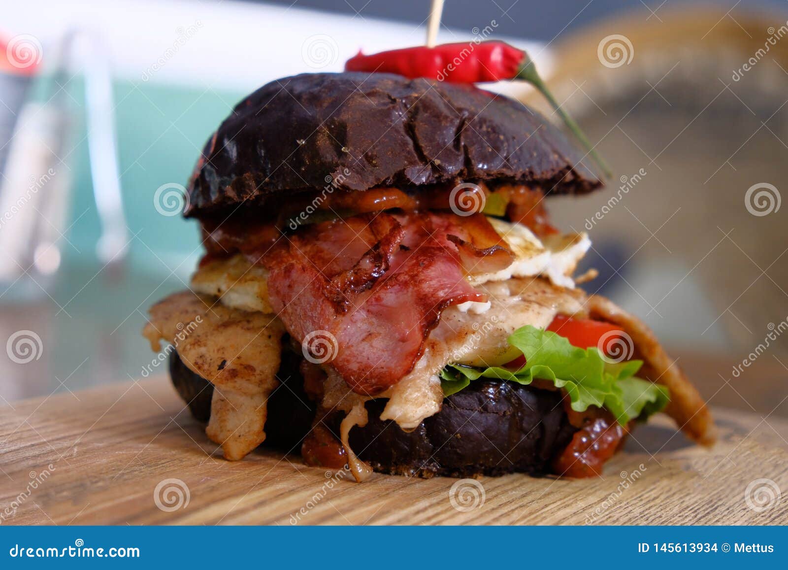Side View of Big Messy Burger Served on Chopping Board Stock Photo ...