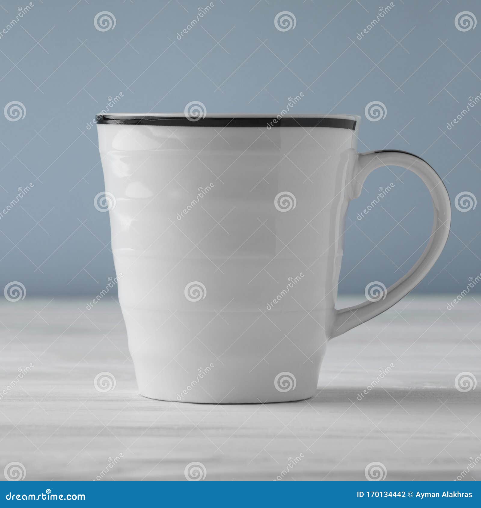 Side View of Blank White Cup on White Table and Blue Background Stock ...