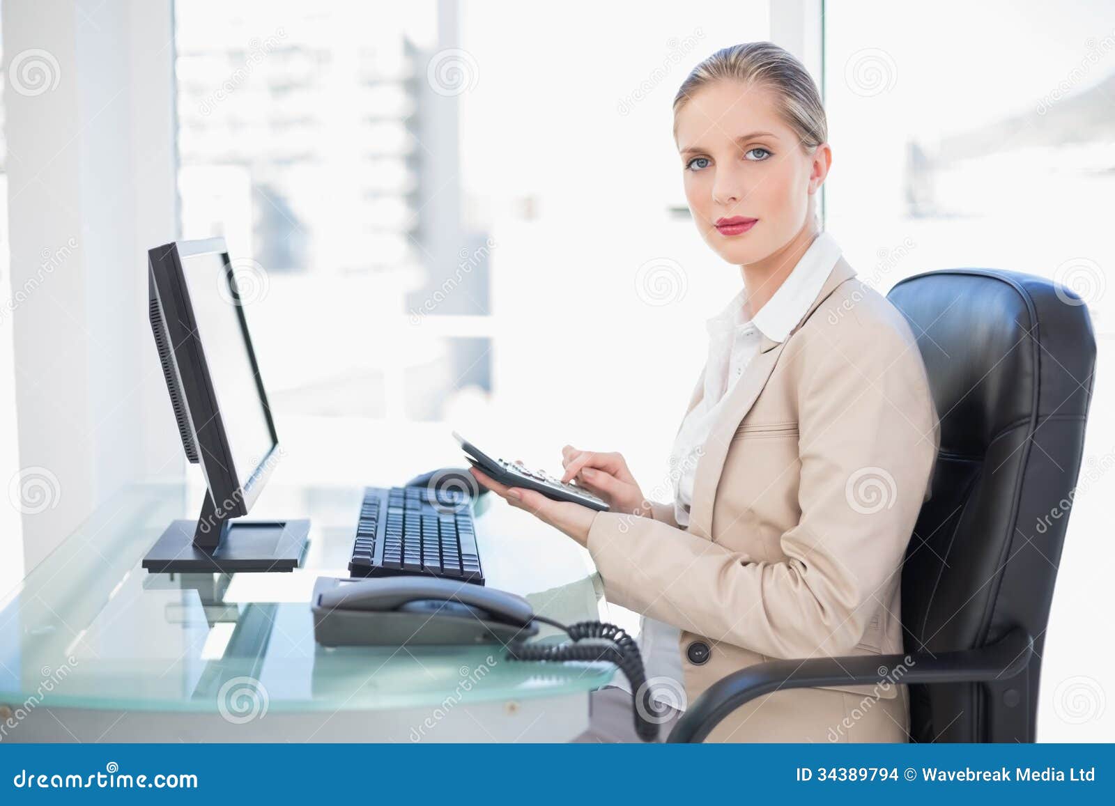 Side View of Blonde Businesswoman Using Calculator Stock Photo - Image ...