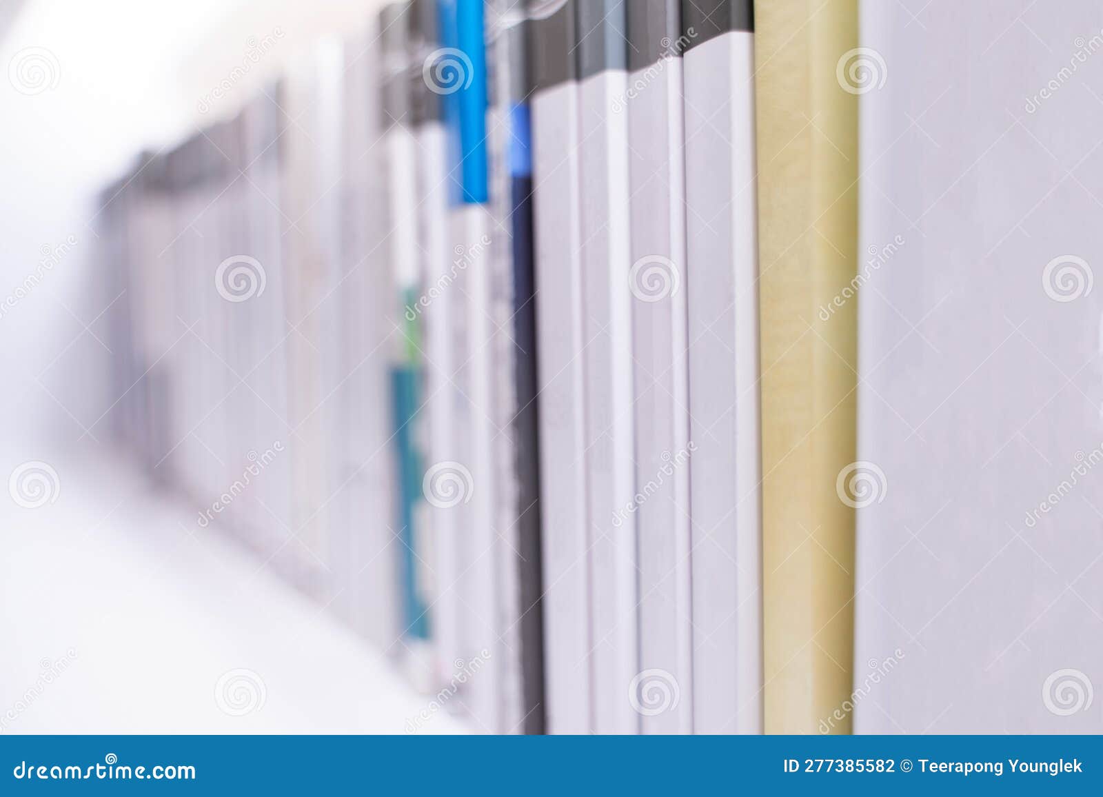Side View of Books Arranged in a Row on a Bookshelf Stock Photo - Image ...