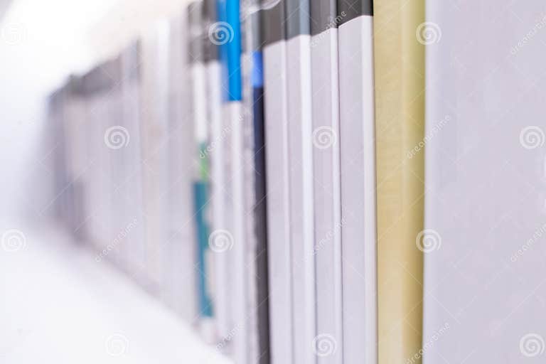 Side View of Books Arranged in a Row on a Bookshelf Stock Photo - Image ...