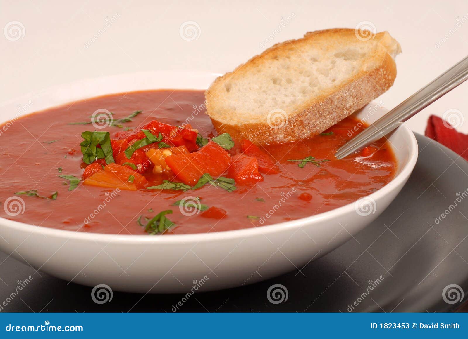 Side View of a Bowl of Tomato, Red Pepper and Basil Soup with Br Stock ...