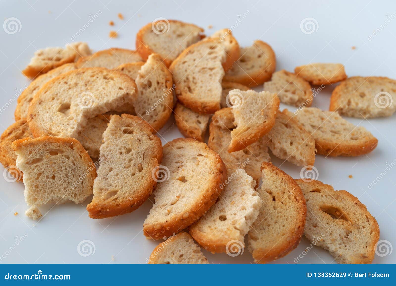 Side View of Broken Pieces of Sesame Round Melba Toast on a White Plate ...