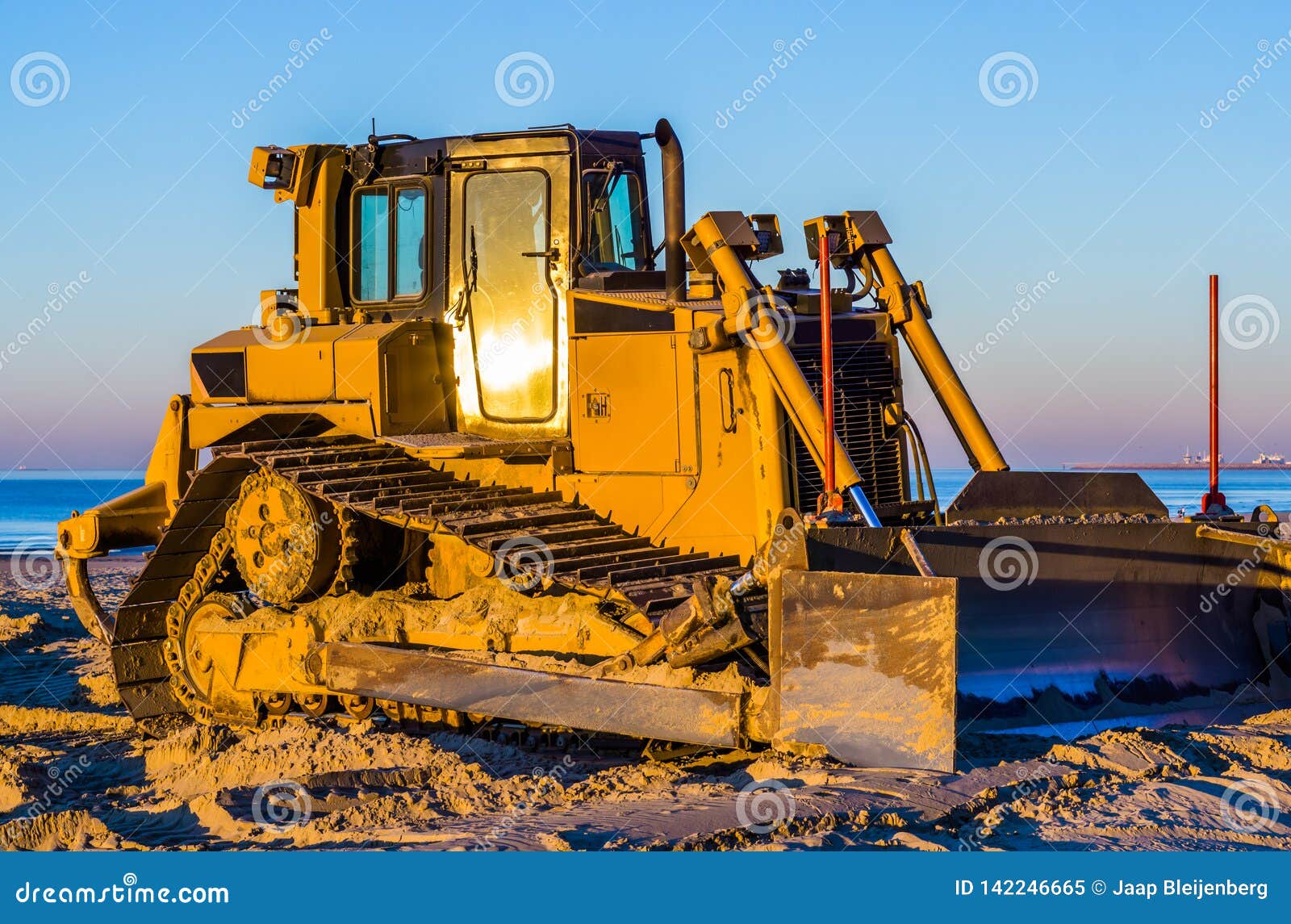 Side View of a Bulldozer with a Scoop on the Beach, Ground Moving ...