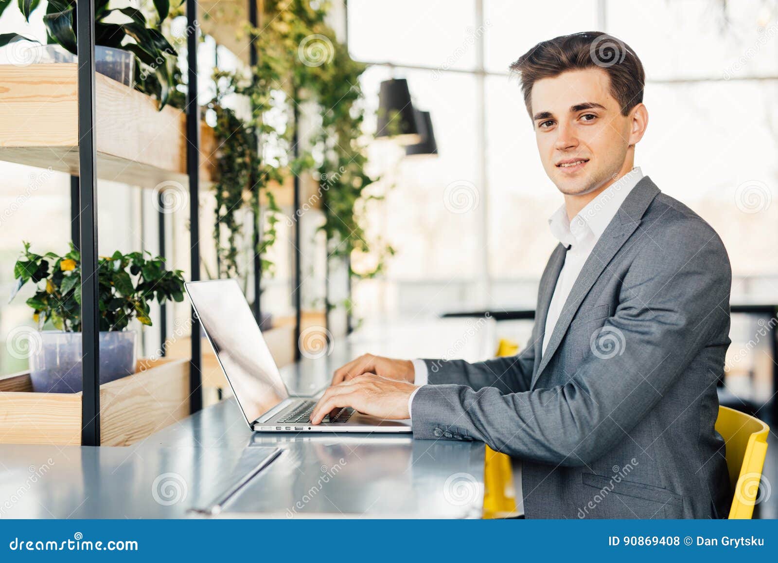 Side View of Business Man Sitting by the Table with Laptop Computer and ...