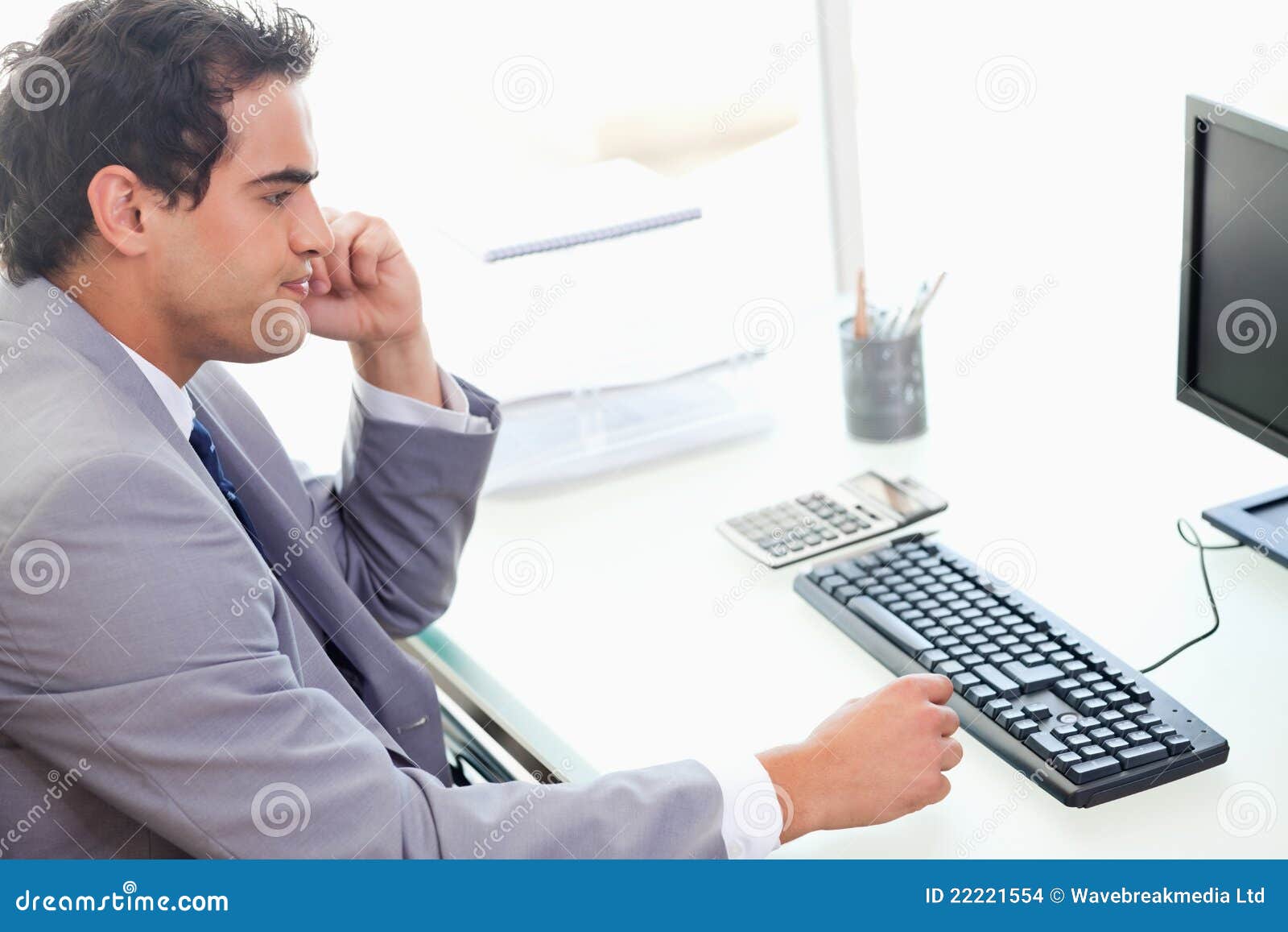 Side View of Businessman Sitting at His Desk Stock Photo - Image of ...