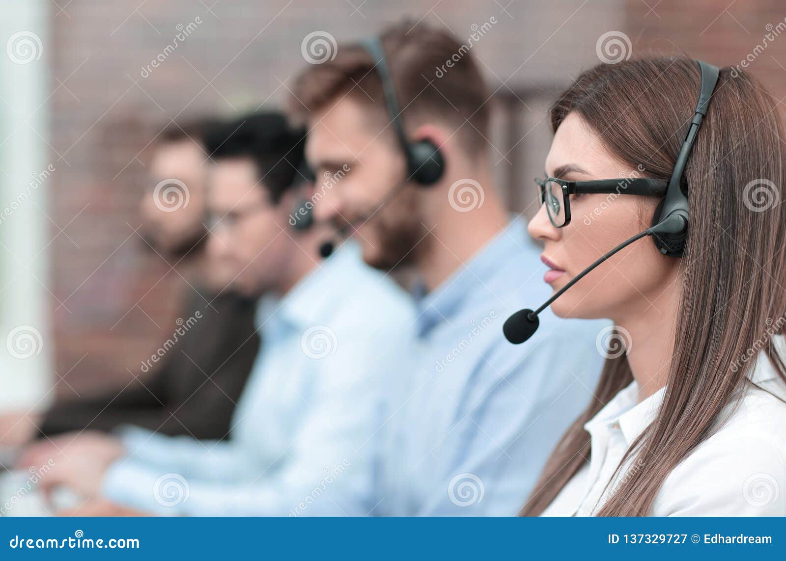 Side View.the Call Center Operator and Her Colleagues Work in the ...