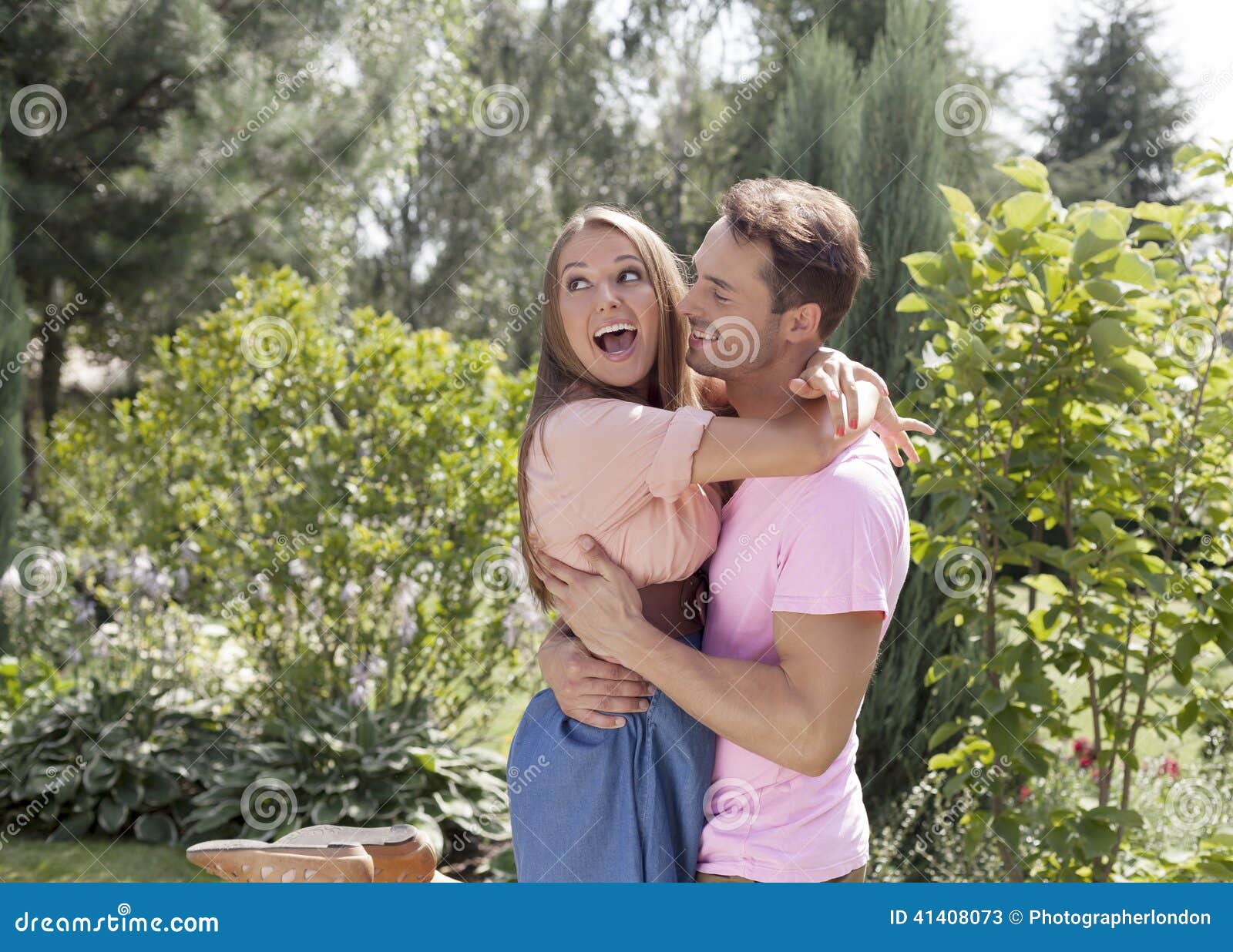 Side View of Cheerful Young Couple Hugging in Park Stock Image - Image ...