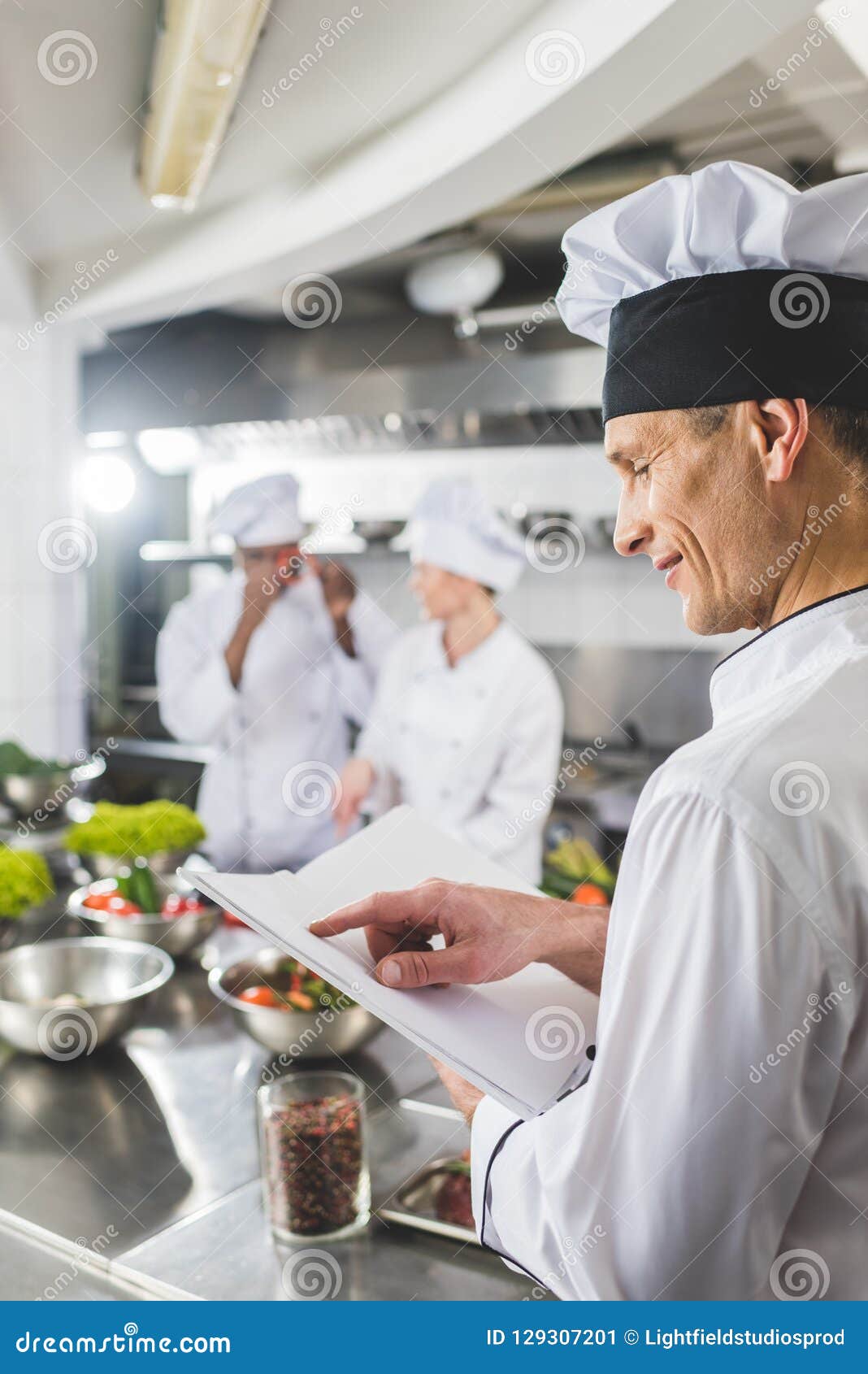 Side View of Chef Pointing on Recipe Book Stock Image - Image of ...