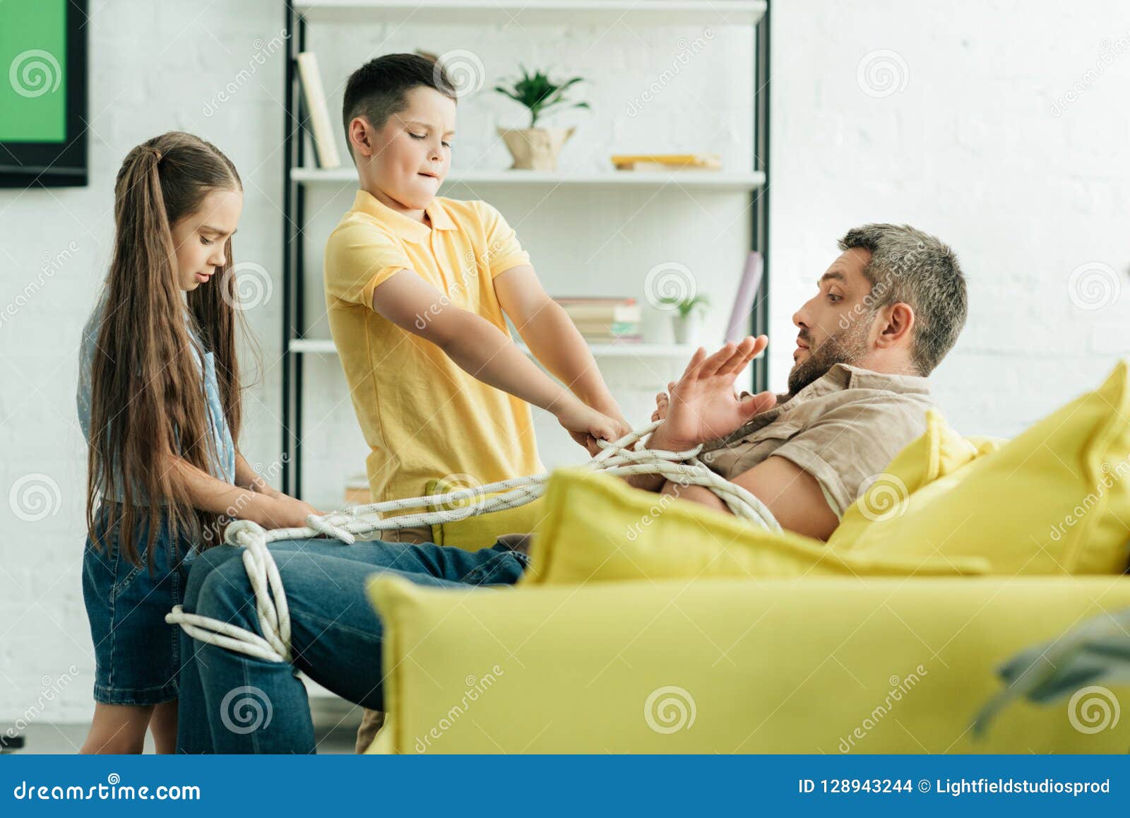 Side View of Children Tying Father with Rope Stock Photo - Image of ...