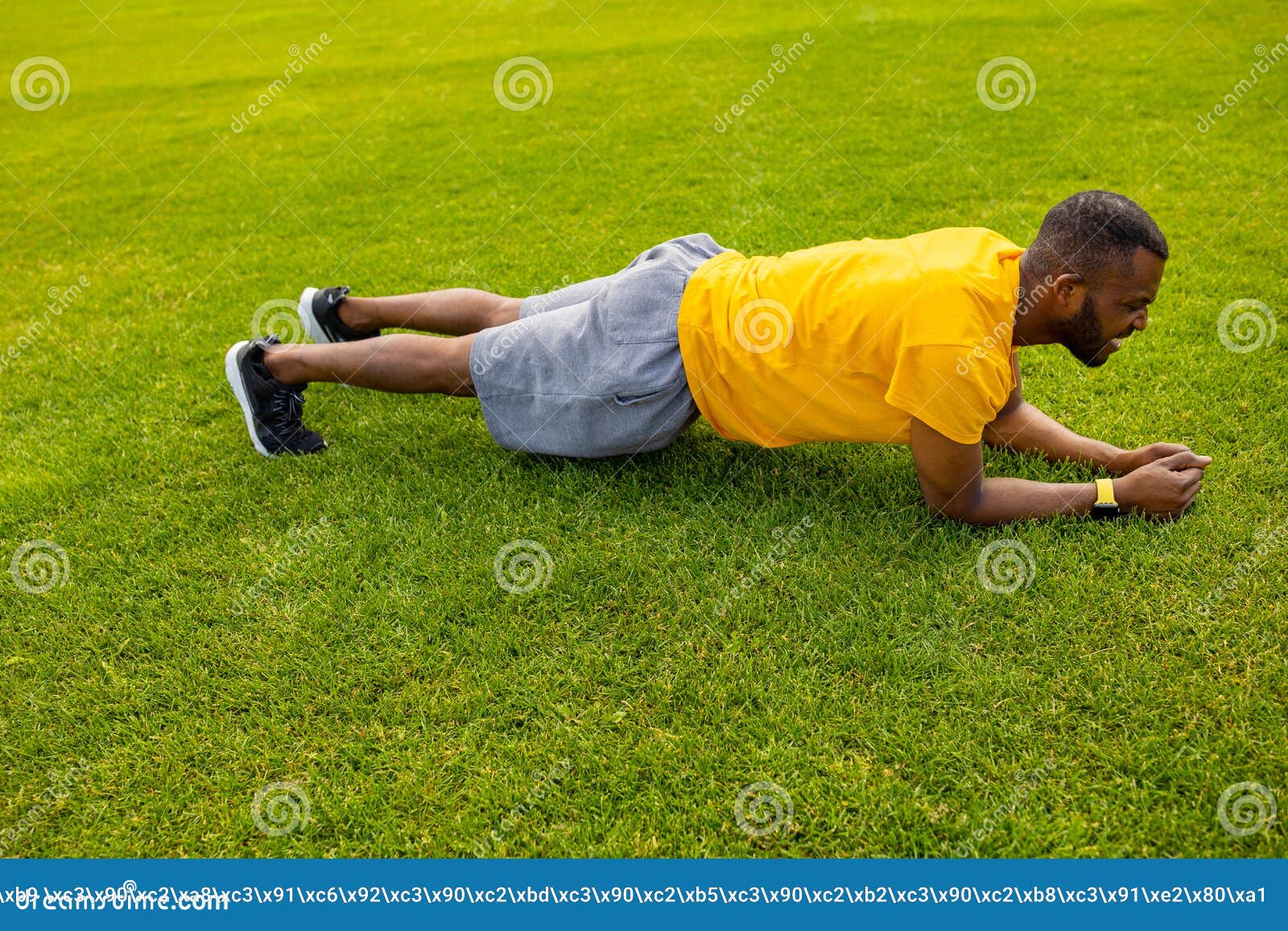 Side View Of Concentrated Afro American Athlete Doing Plank Exercise On