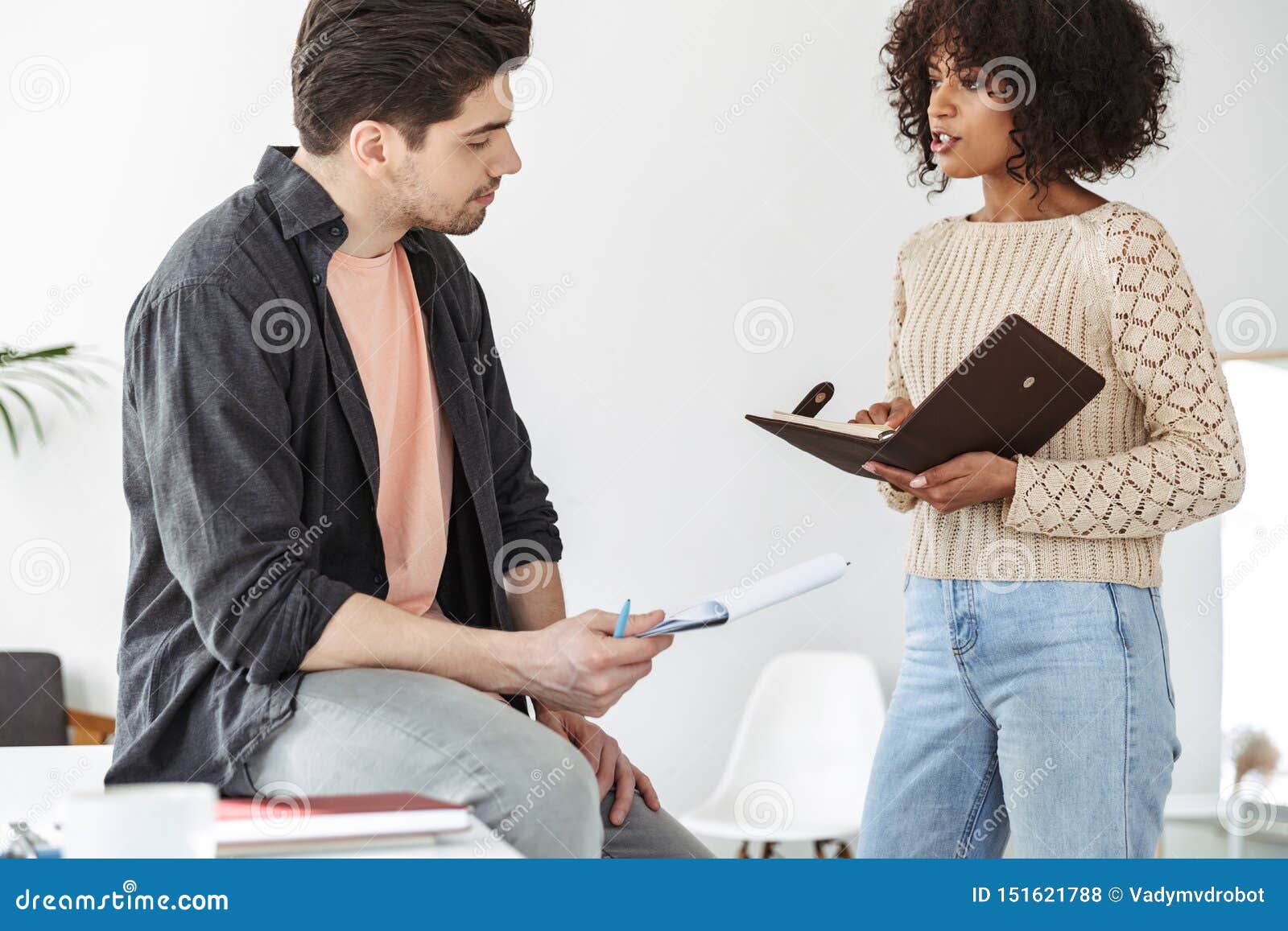 Side View of Concentrated Young Colleagues Working Together Stock Photo ...