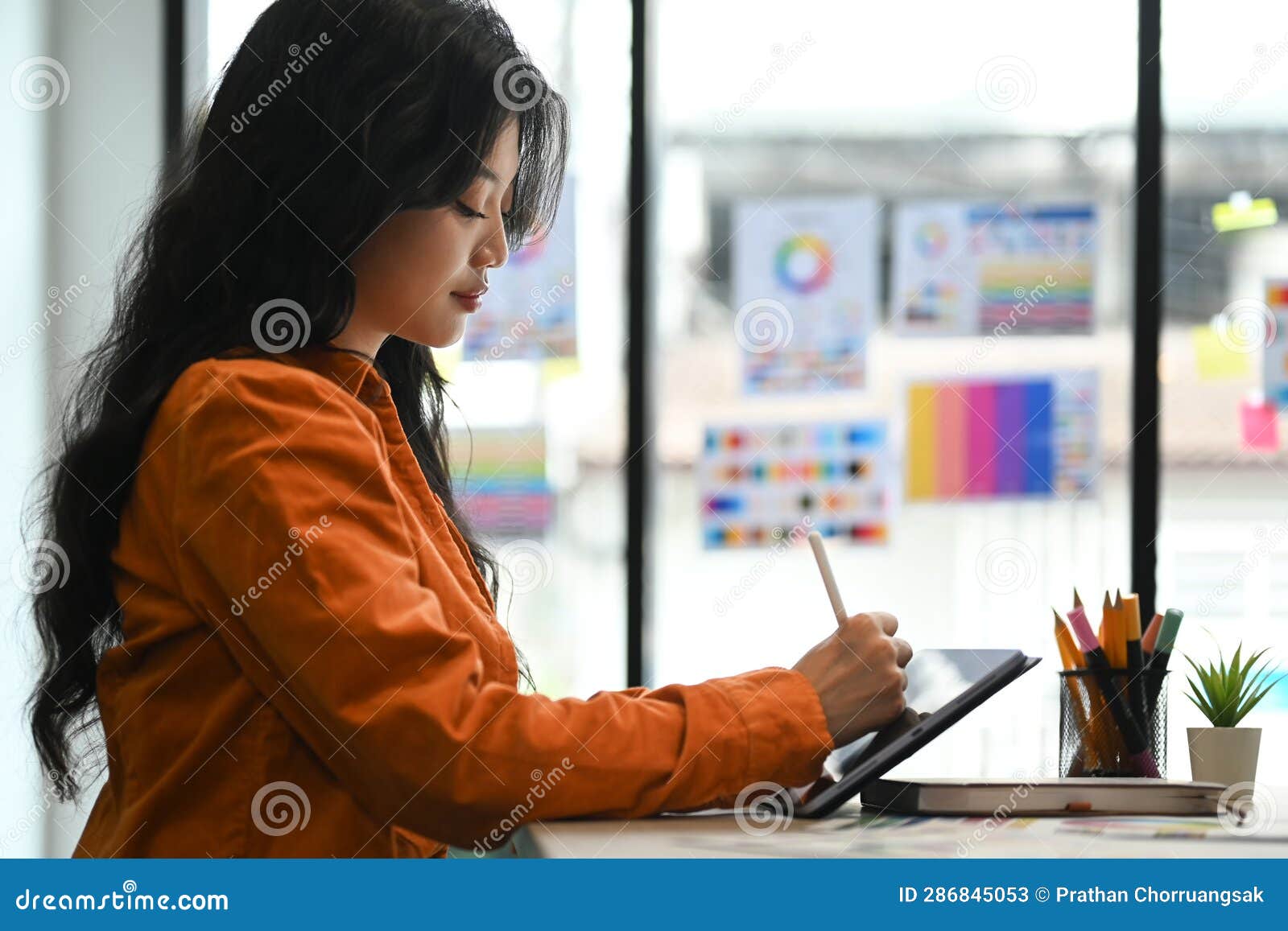 Side View of Concentrated Young Creative Woman Working on Project ...