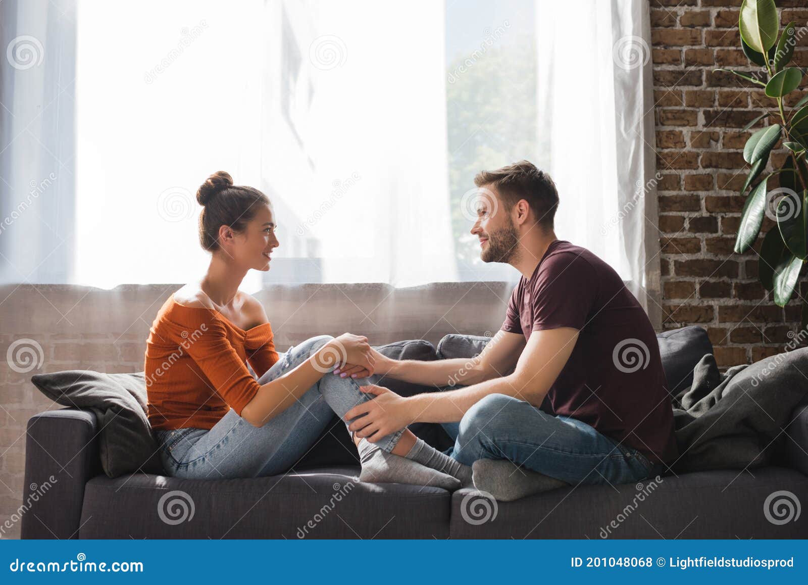 Side View of Couple Talking while Stock Photo - Image of smiling, home ...