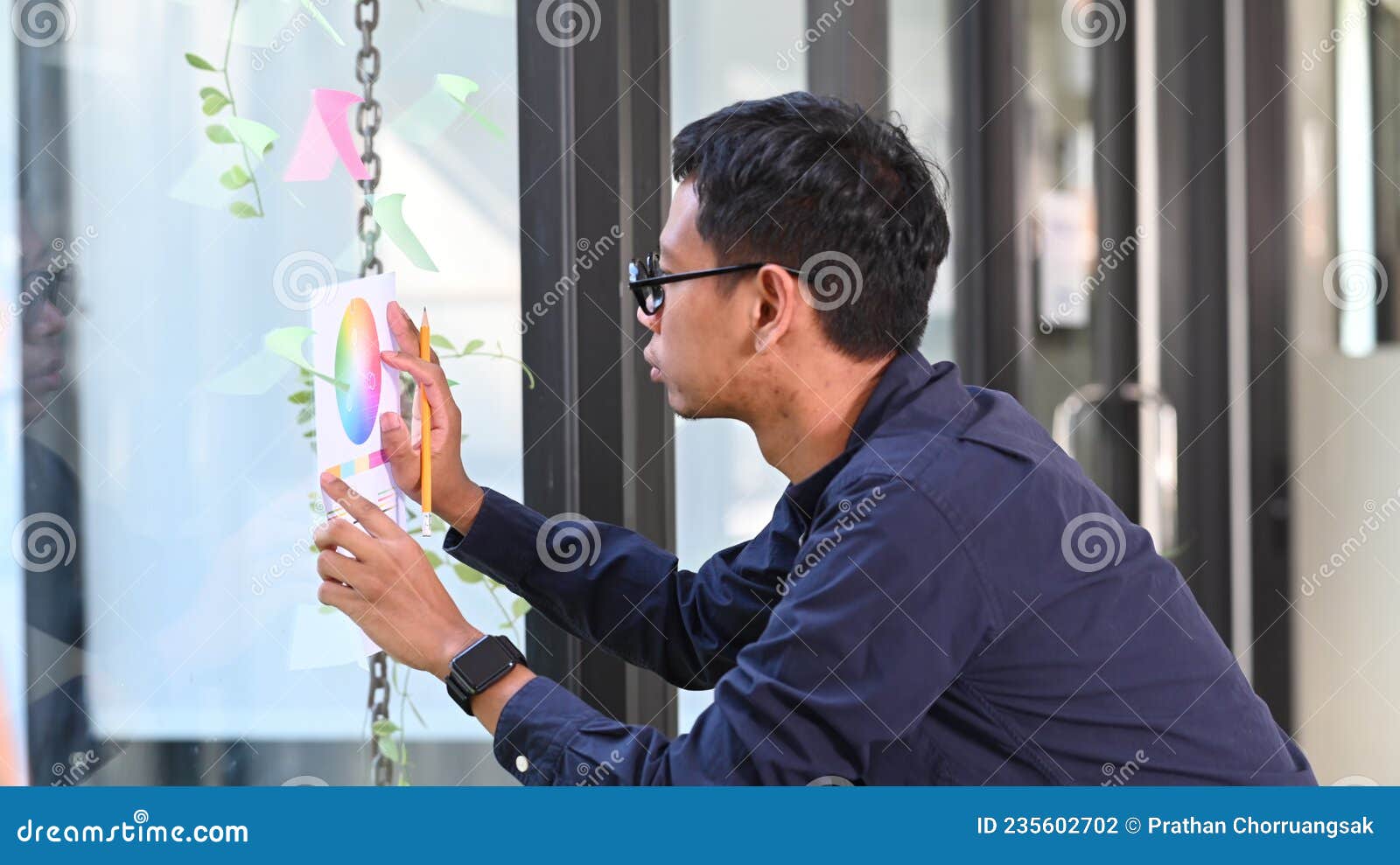 Creative Man Reading Sticky Notes on the Glass Wall in Office. Stock ...