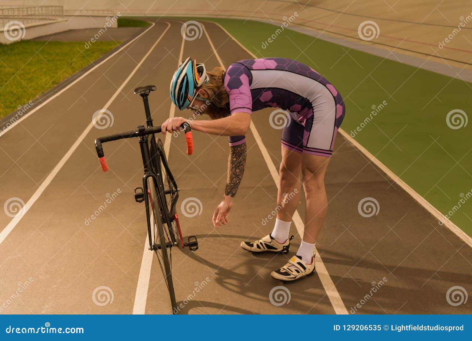 Side View of Cyclist Checking Bicycle Wheel while Standing on Cycle ...