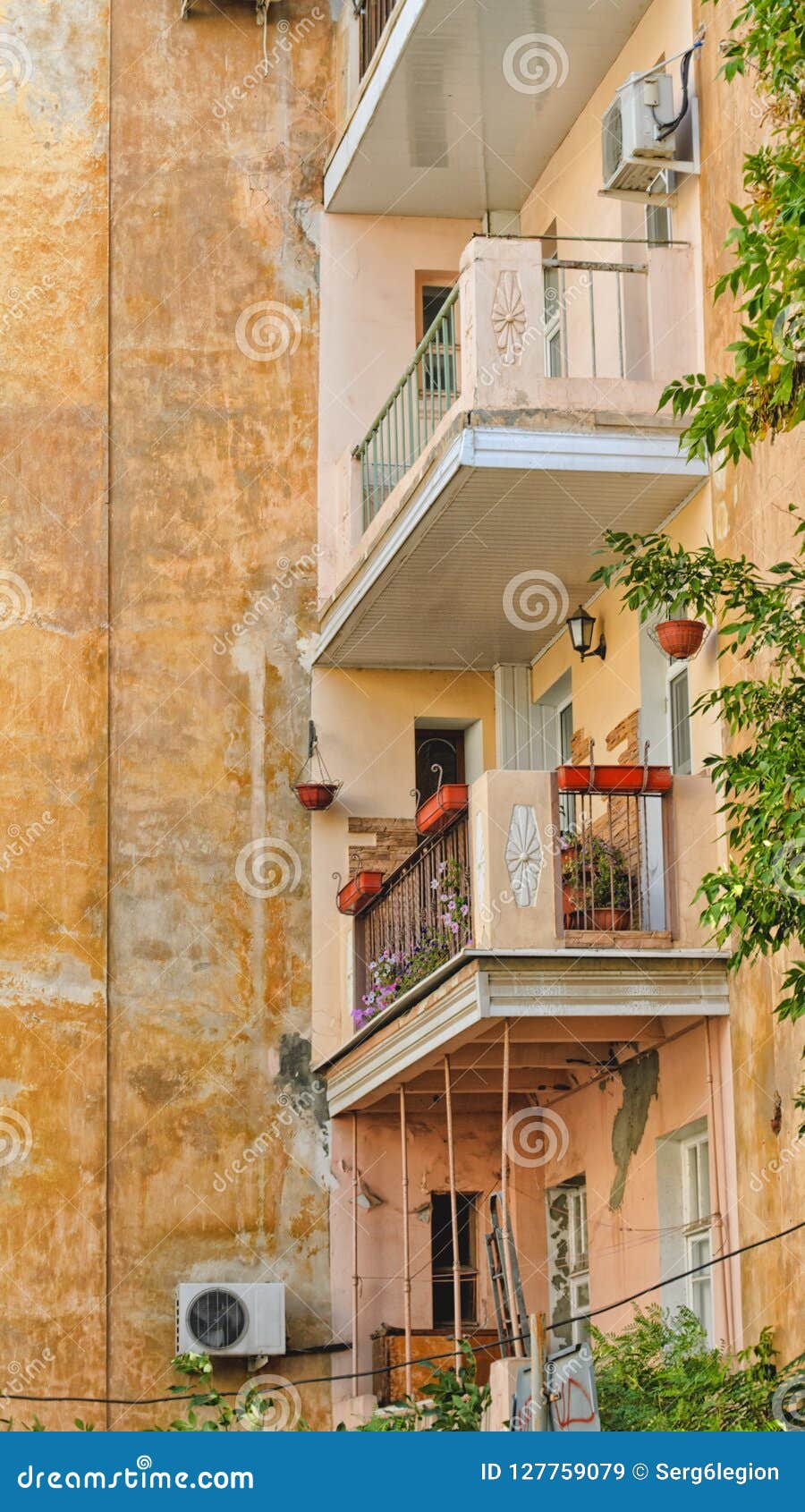 Side View on a Decayed Facade of the Old House with Balconies. Stock ...