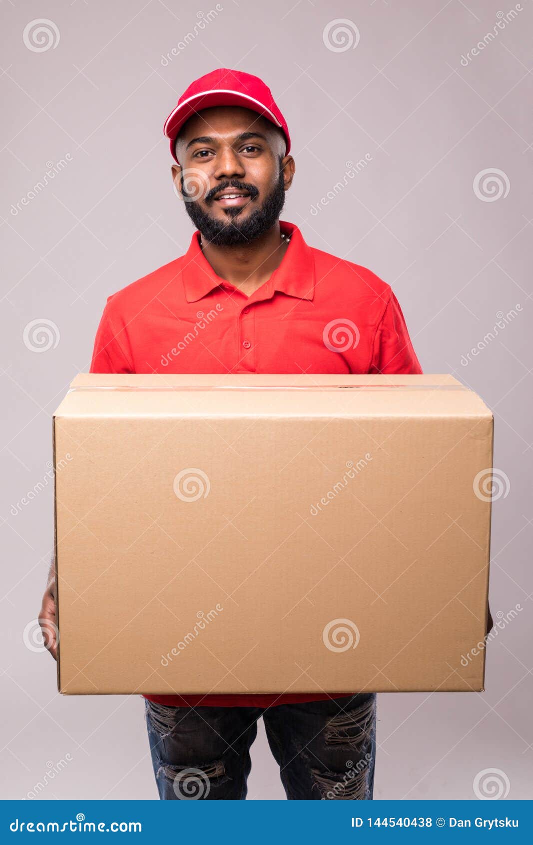 Side View of Indian Delivery Man with Box in Studio. Isolated Gray ...