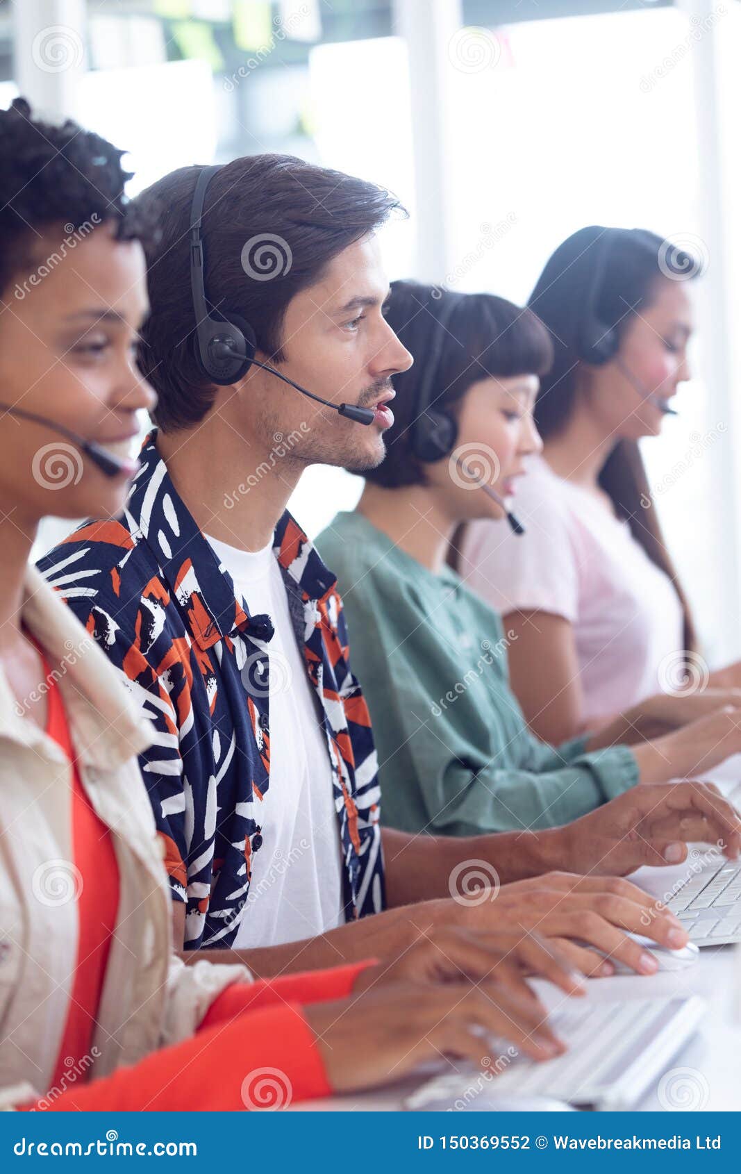 Customer Service Executives Working on Computer at Desk Stock Photo ...