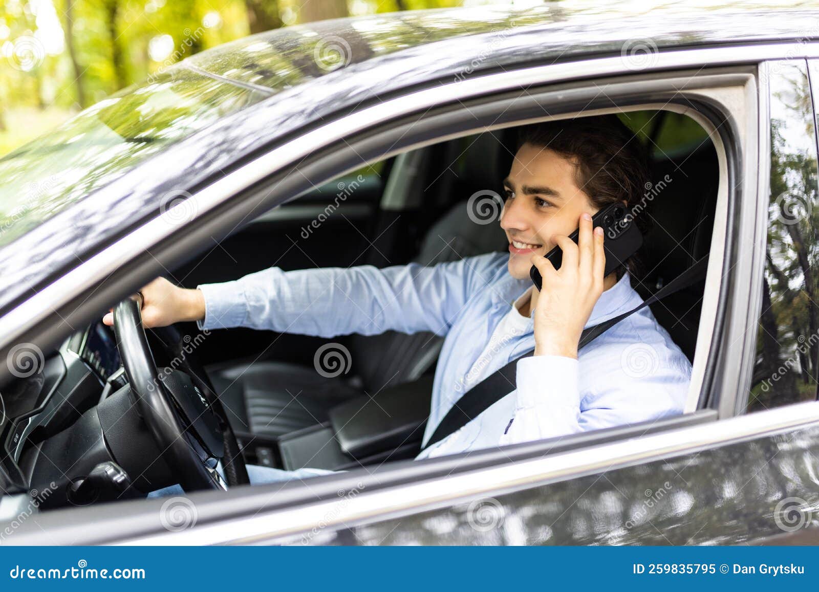 Side View of Elegant Driver Talking on Mobile Phone and Watching for ...