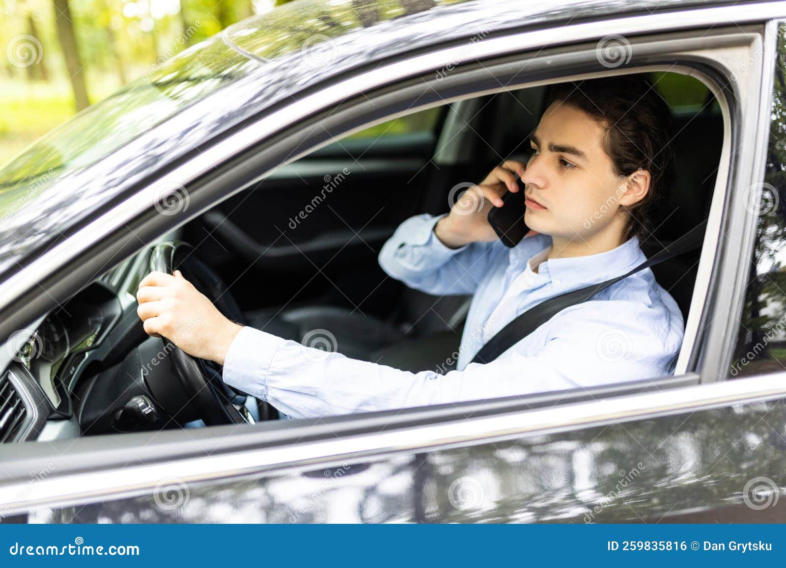 Side View of Elegant Driver Talking on Mobile Phone and Watching for ...