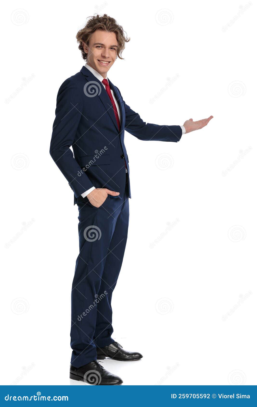 Side View of Elegant Guy in Suit with Hand in Pockets Presenting To ...