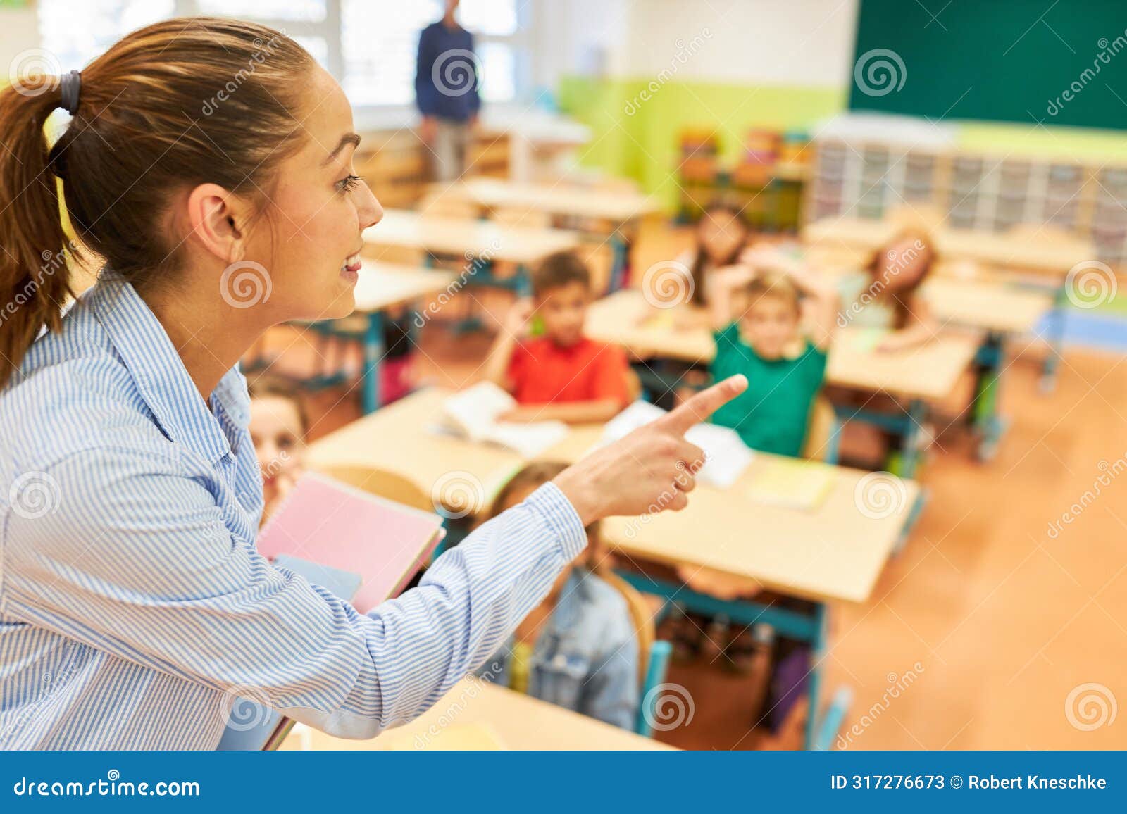 Elementary School Teacher Pointing in Class Stock Image - Image of ...
