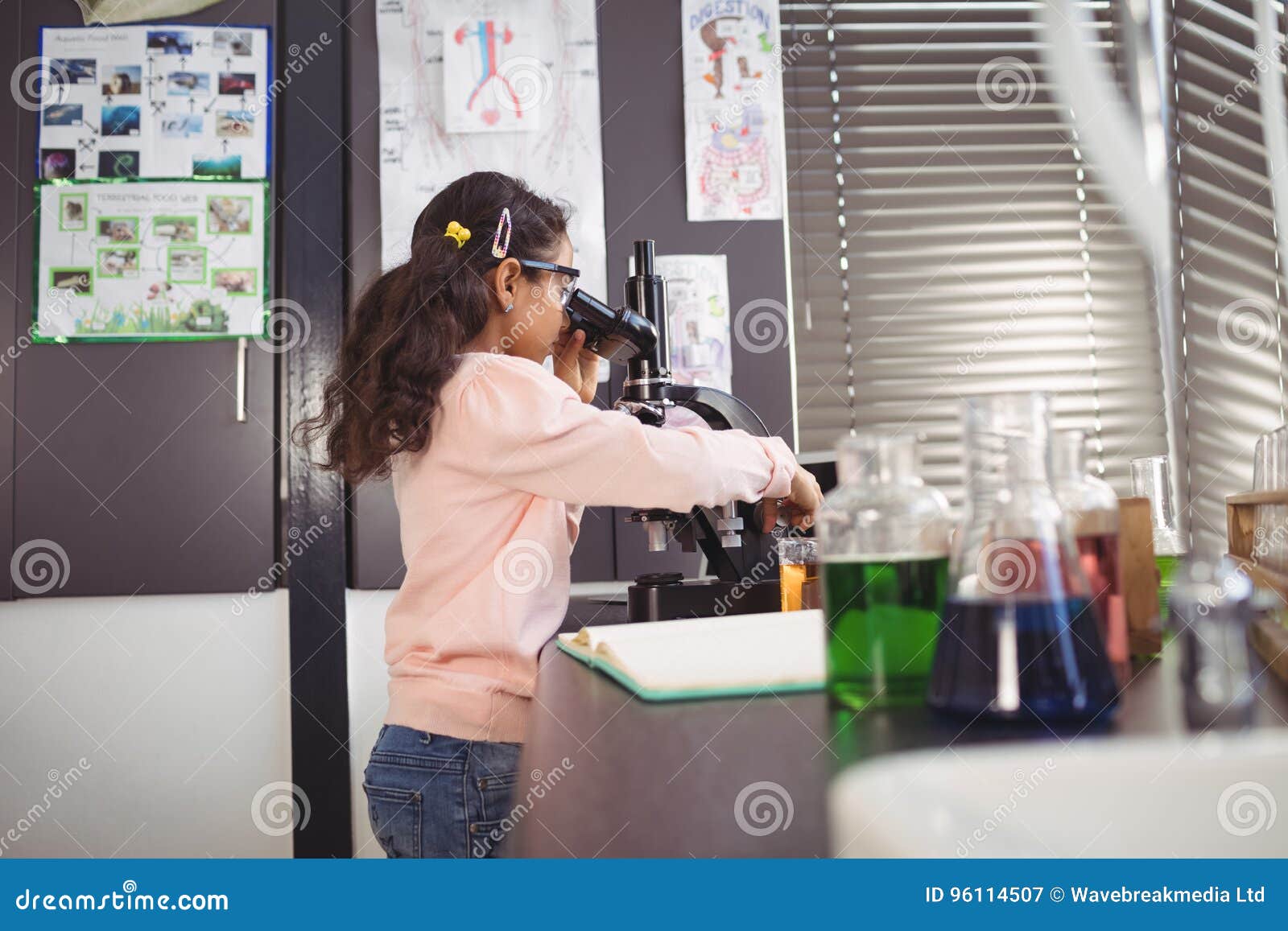 Side View of Elementary Schoolgirl Using Microscope at Laboratory Stock ...