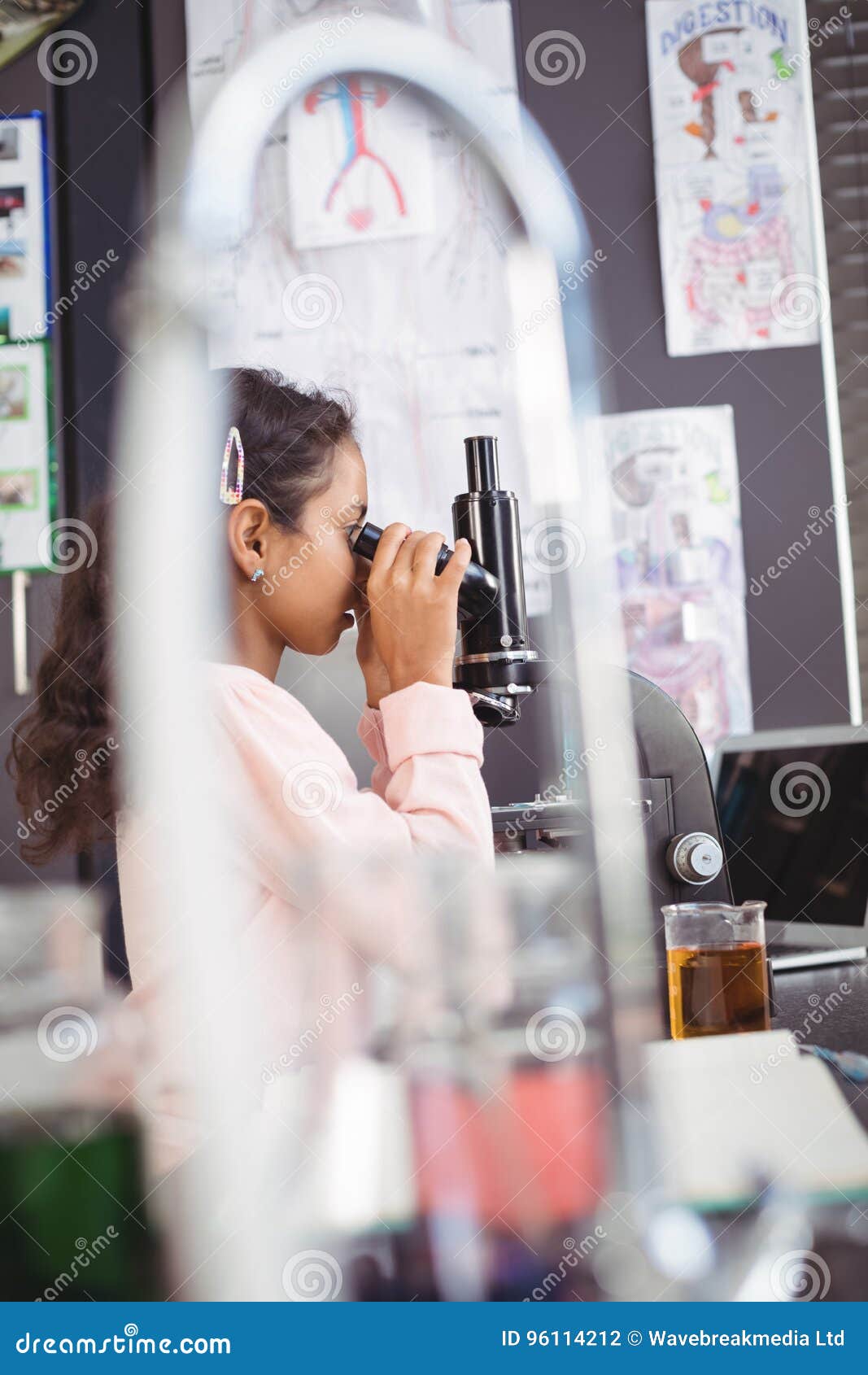 Side View of Elementary Student Looking through Microscope at ...