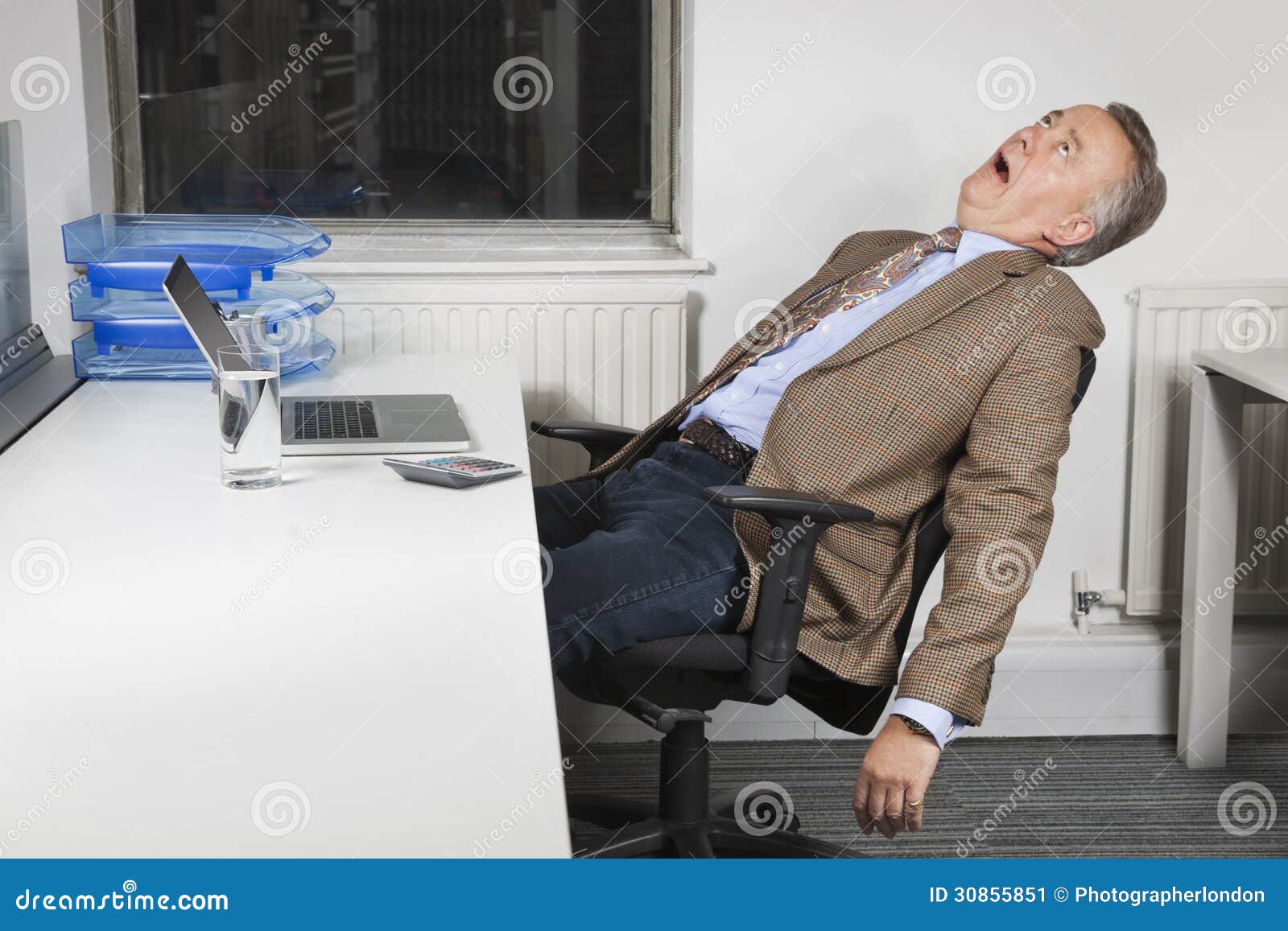 Side View of Exhausted Middle-aged Businessman in Front of Laptop in ...