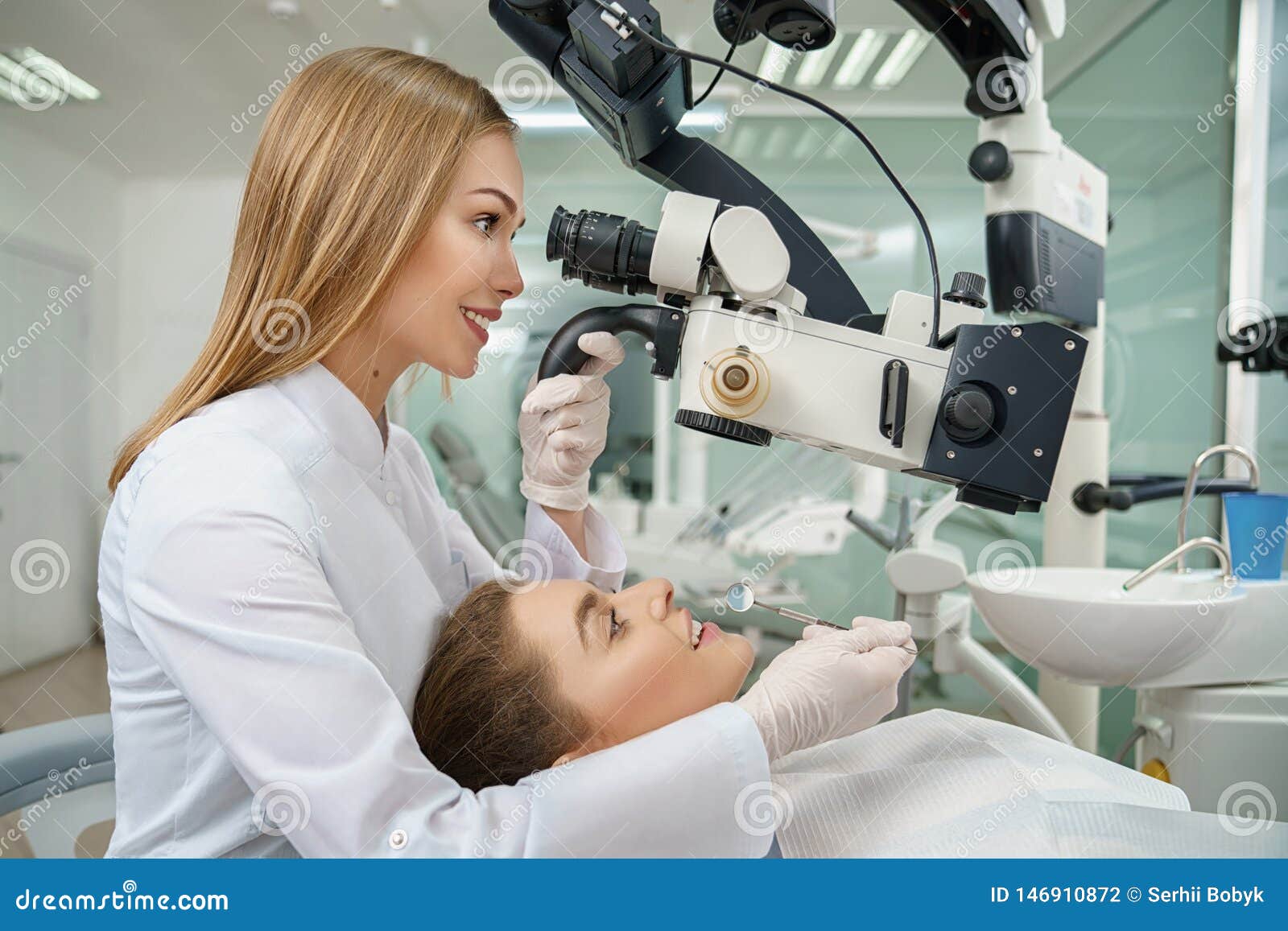 Side View of Experienced Dentist Looking at Microscope Stock Photo ...