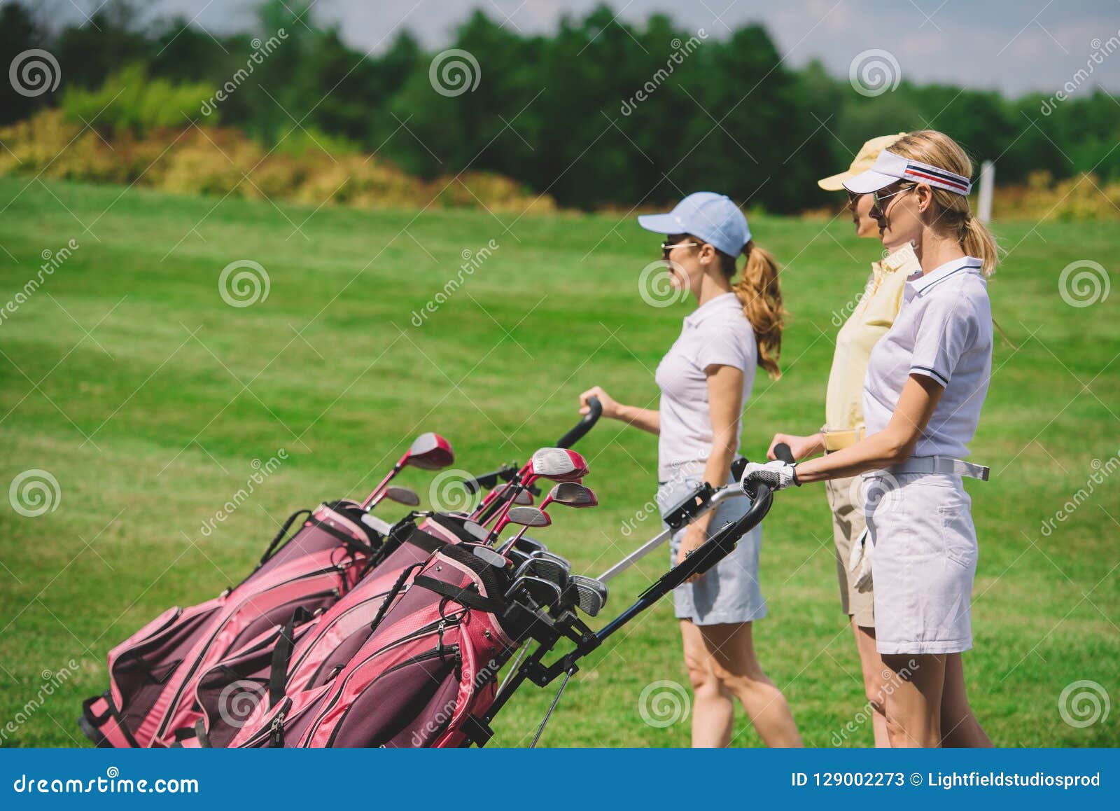 Side View of Female Golfers with Golf Equipment Walking Stock Image ...