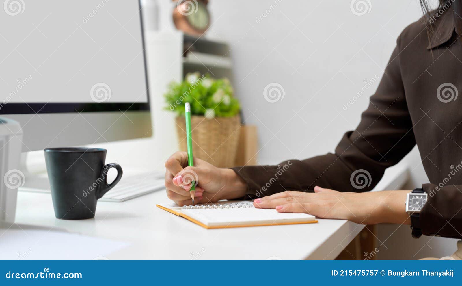 Side View of Female Hand Writing on Notebook on Computer Table Stock ...