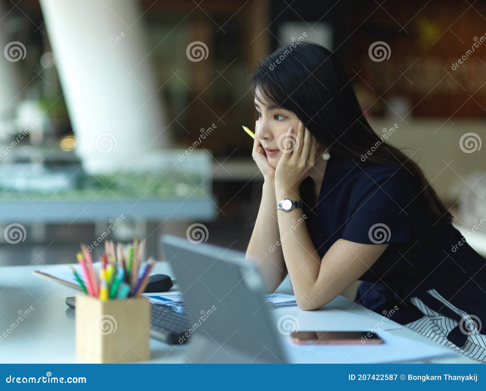 Female Office Worker Thinking about Her Project while Working with ...