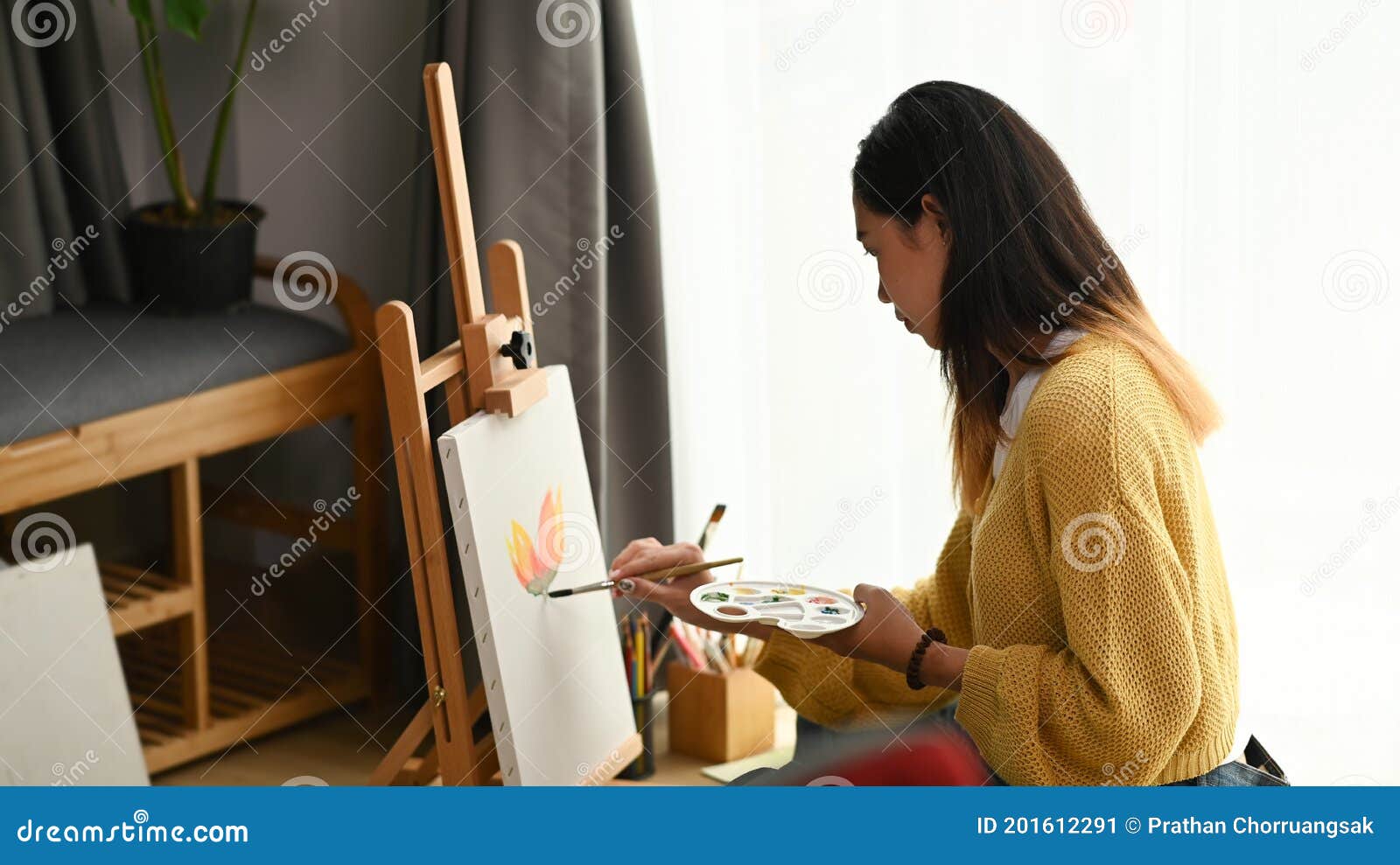 Side View of a Female Painter is Drawing a Picture with Poster Paint ...