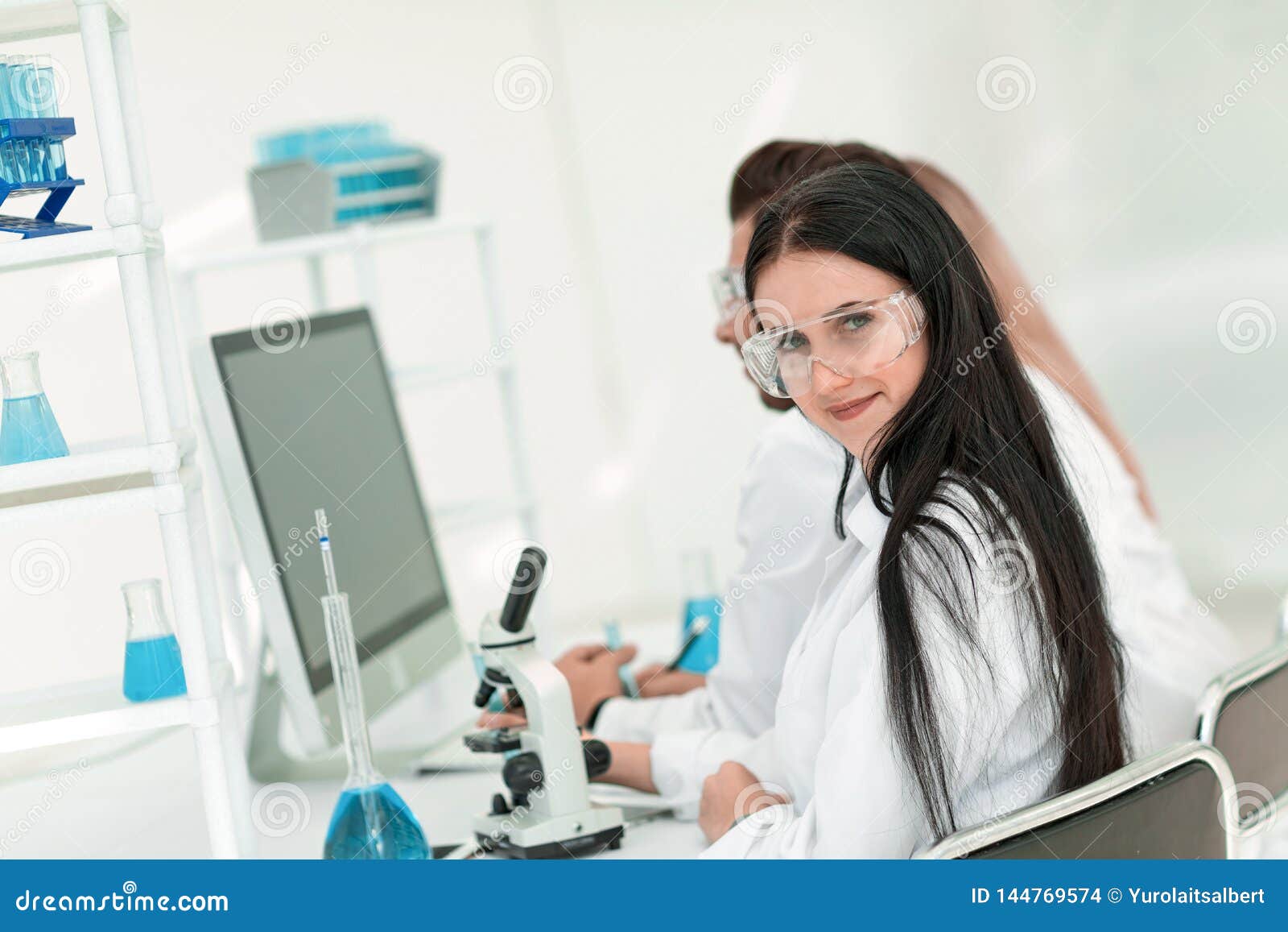 Side View.female Scientist Sitting at a Lab Table Stock Photo - Image ...
