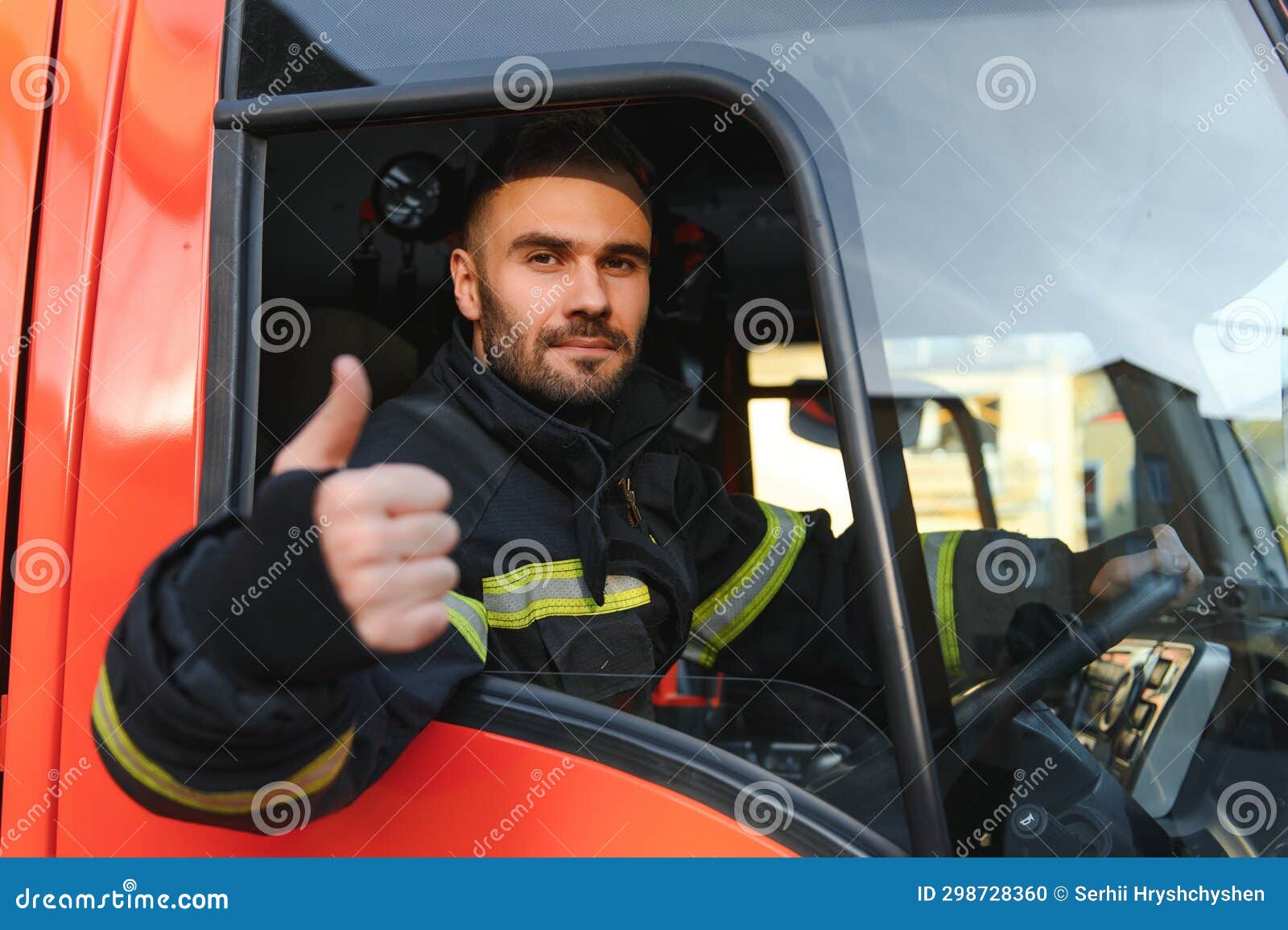 Side View of Firefighter in Protective Uniform Driving Fire Engine ...