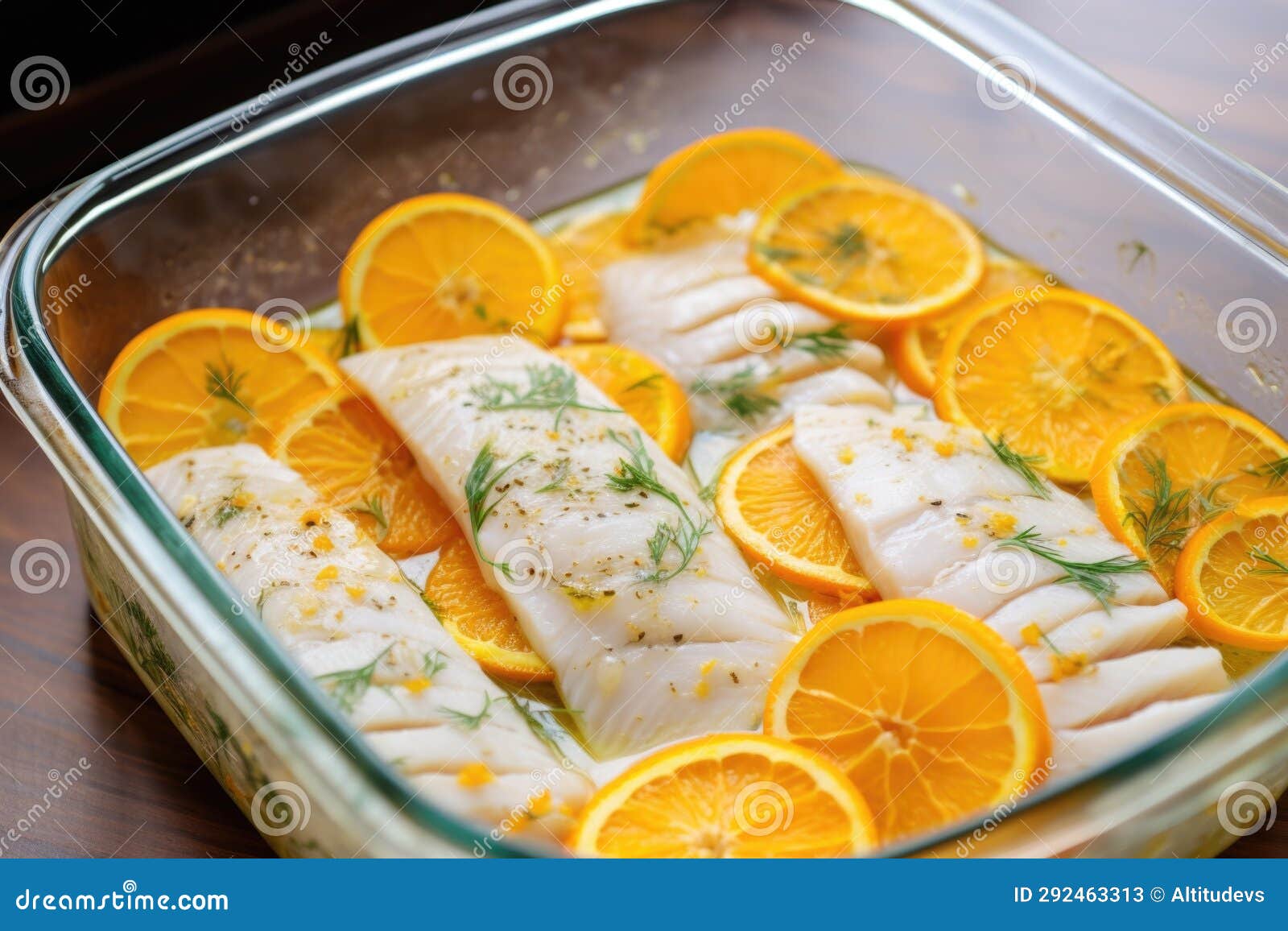 Side View of Fish Fillets Marinating with Thinly Sliced Oranges Stock ...